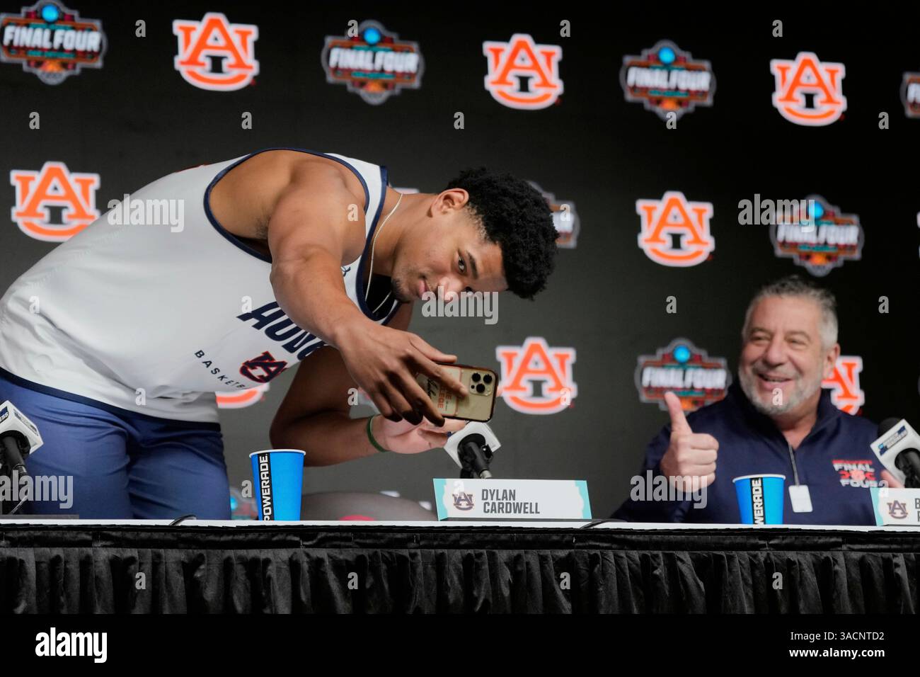 Auburn's Dylan Cardwell, left, takes a photograph of his nameplate as ...