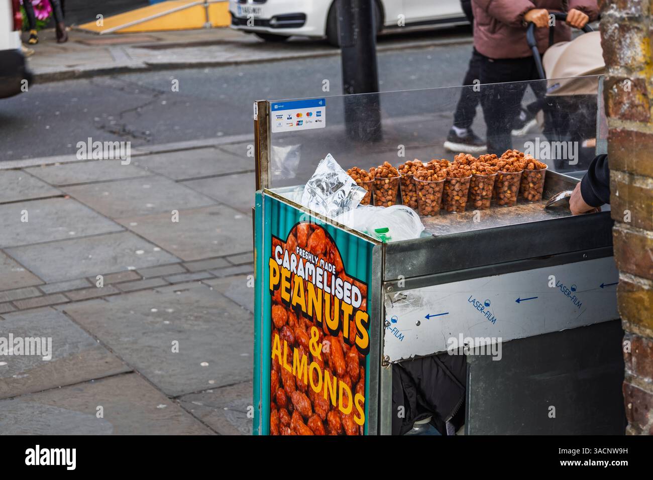 Roasted chestnut stall on sidewalk in Camden Town street scene. London ...