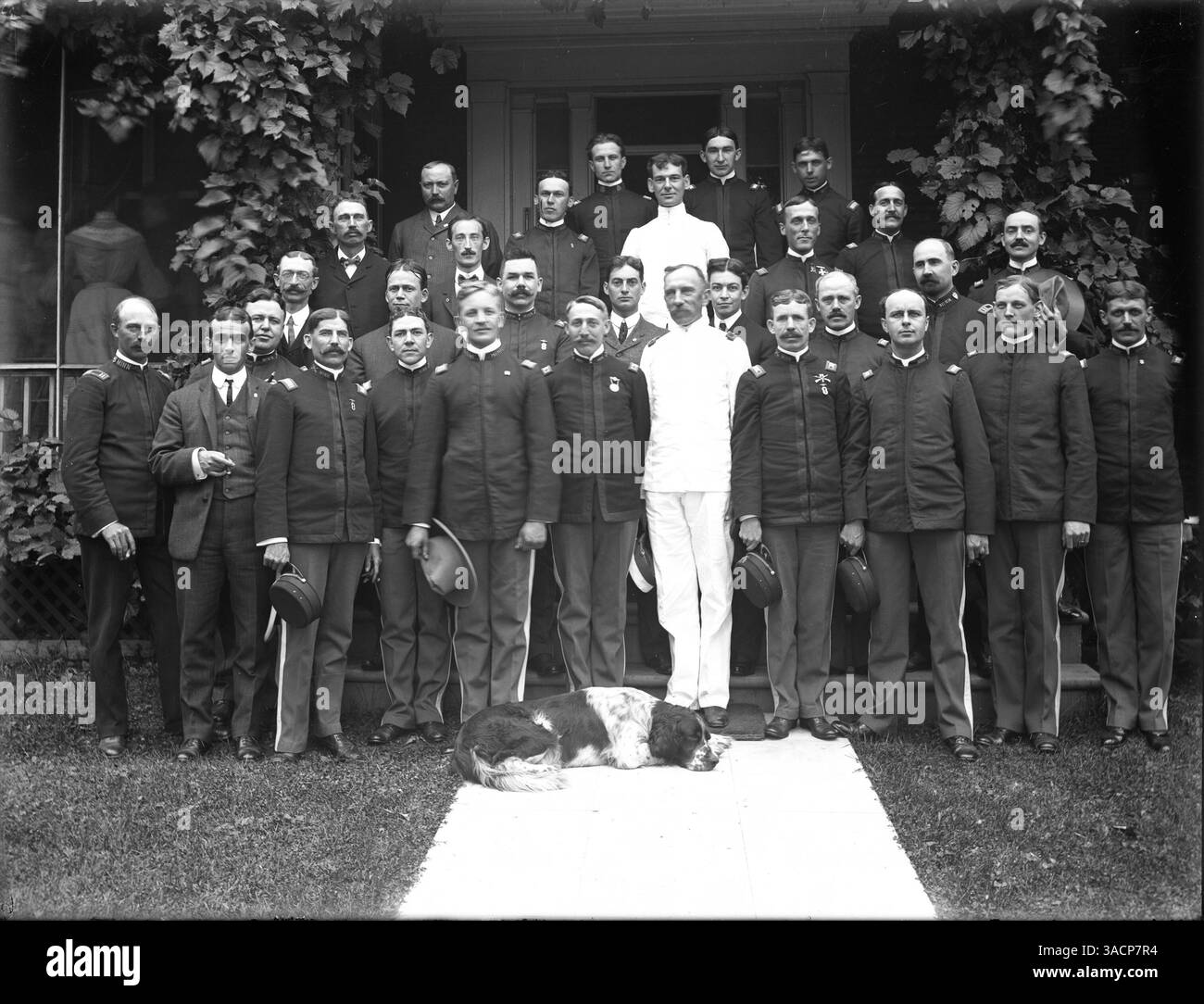 Officers of the 13th Minnesota Regiment pose with a sleeping dog during ...
