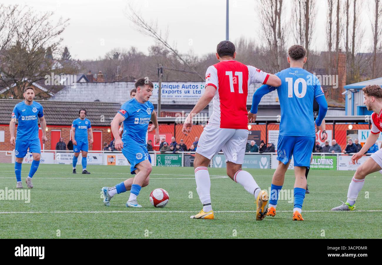 Jake Burton heads toward goal for Warrington Rylands chased by an ...