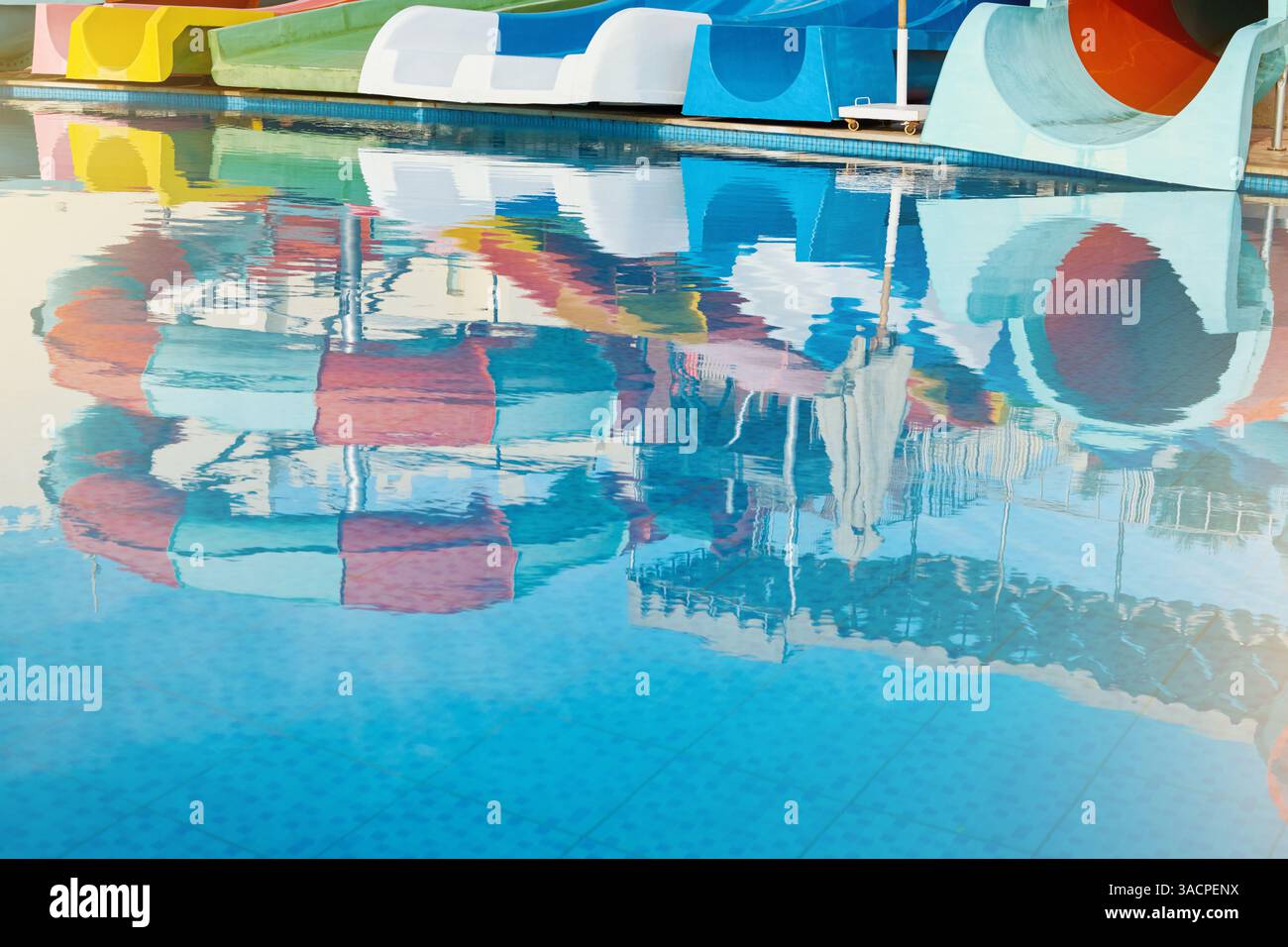 Reflection of water park with water colored flights in pool, slides ...