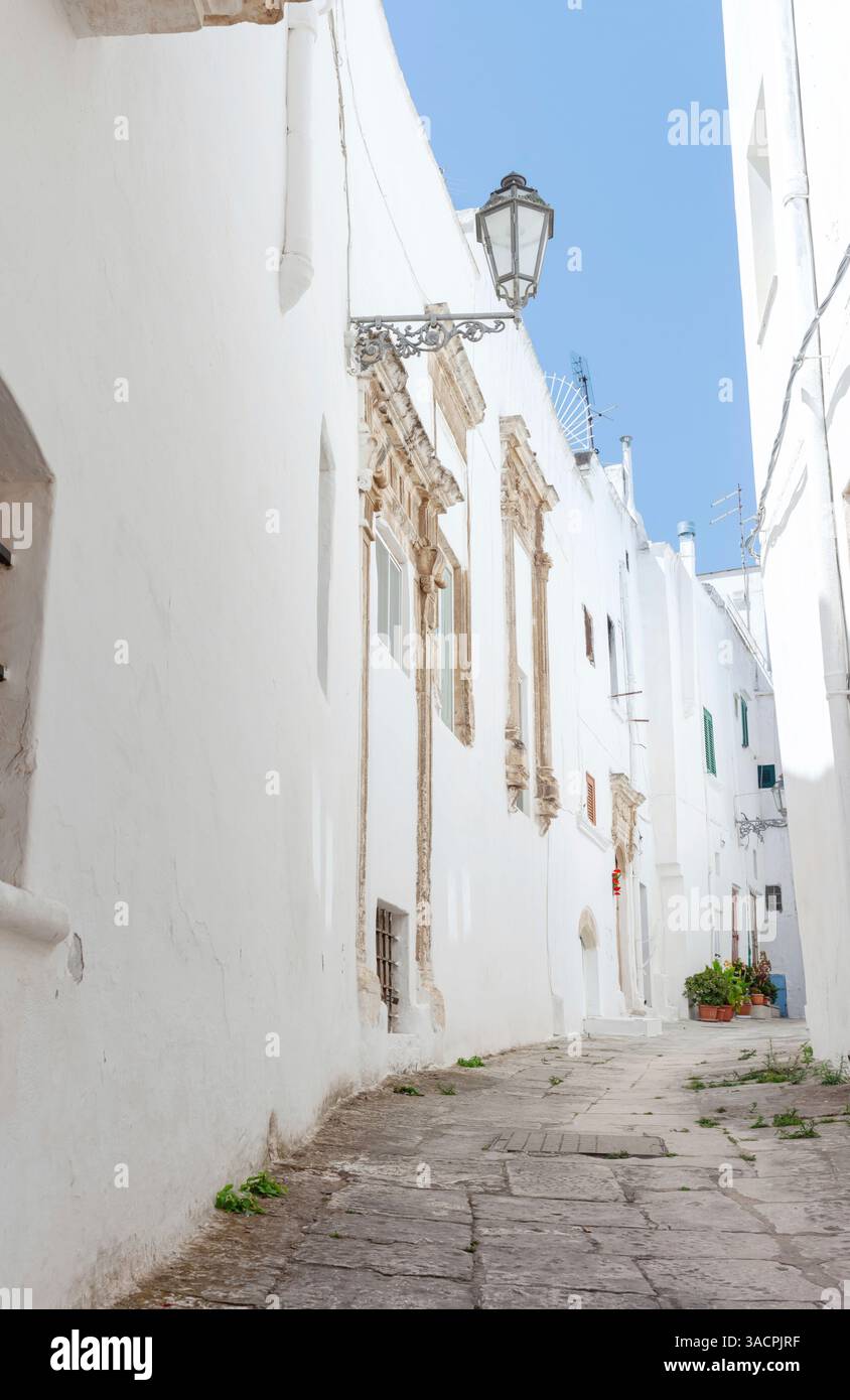 Whitewashed buildings and narrow street in ostuni hi-res stock ...