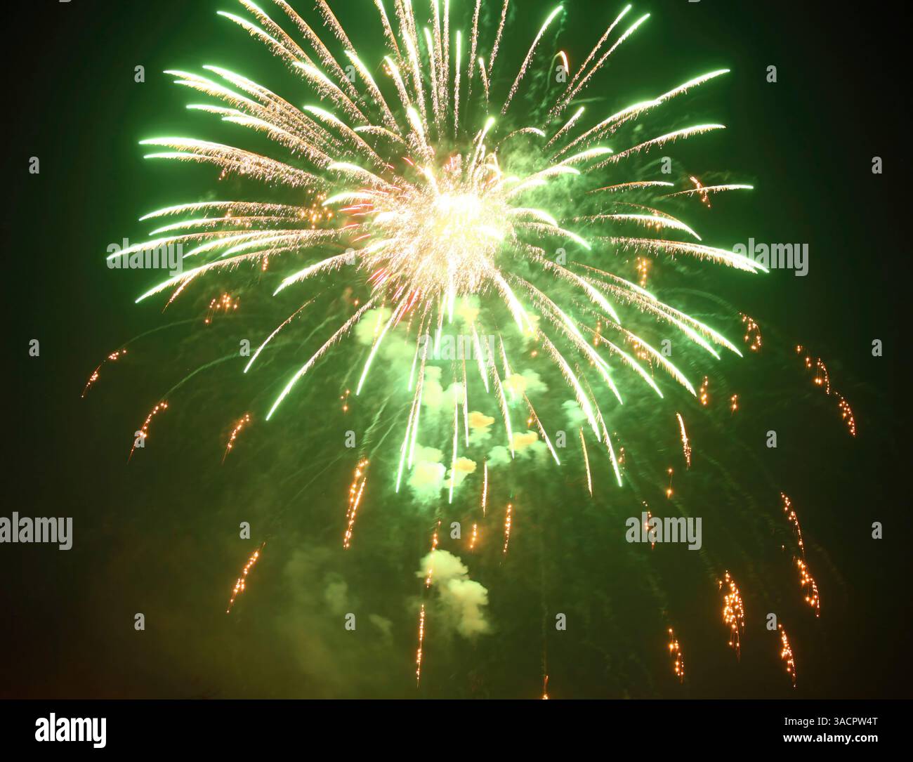 Green fireworks exploding creating beautiful light trails in the night ...