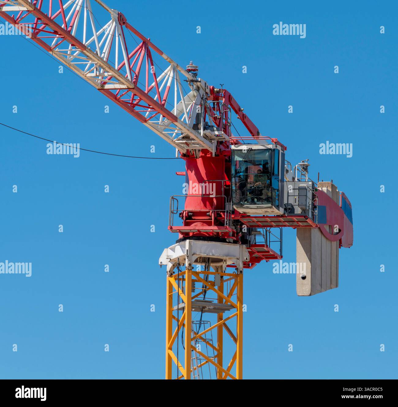 Tower crane detail with operators cab in front of blue sky Stock Photo ...