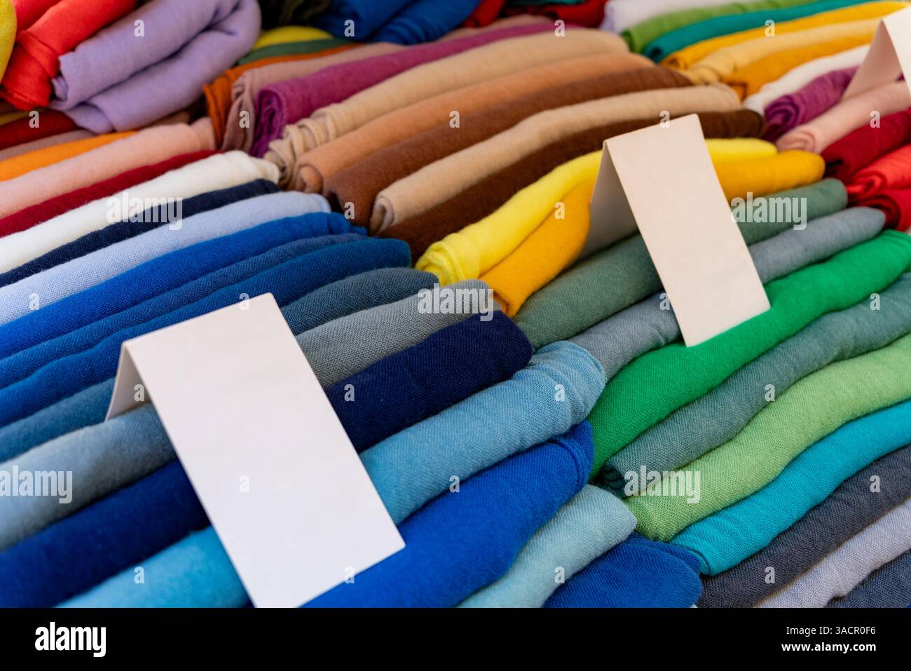 Full frame closeup shot showing a display of various colorful fabrics ...