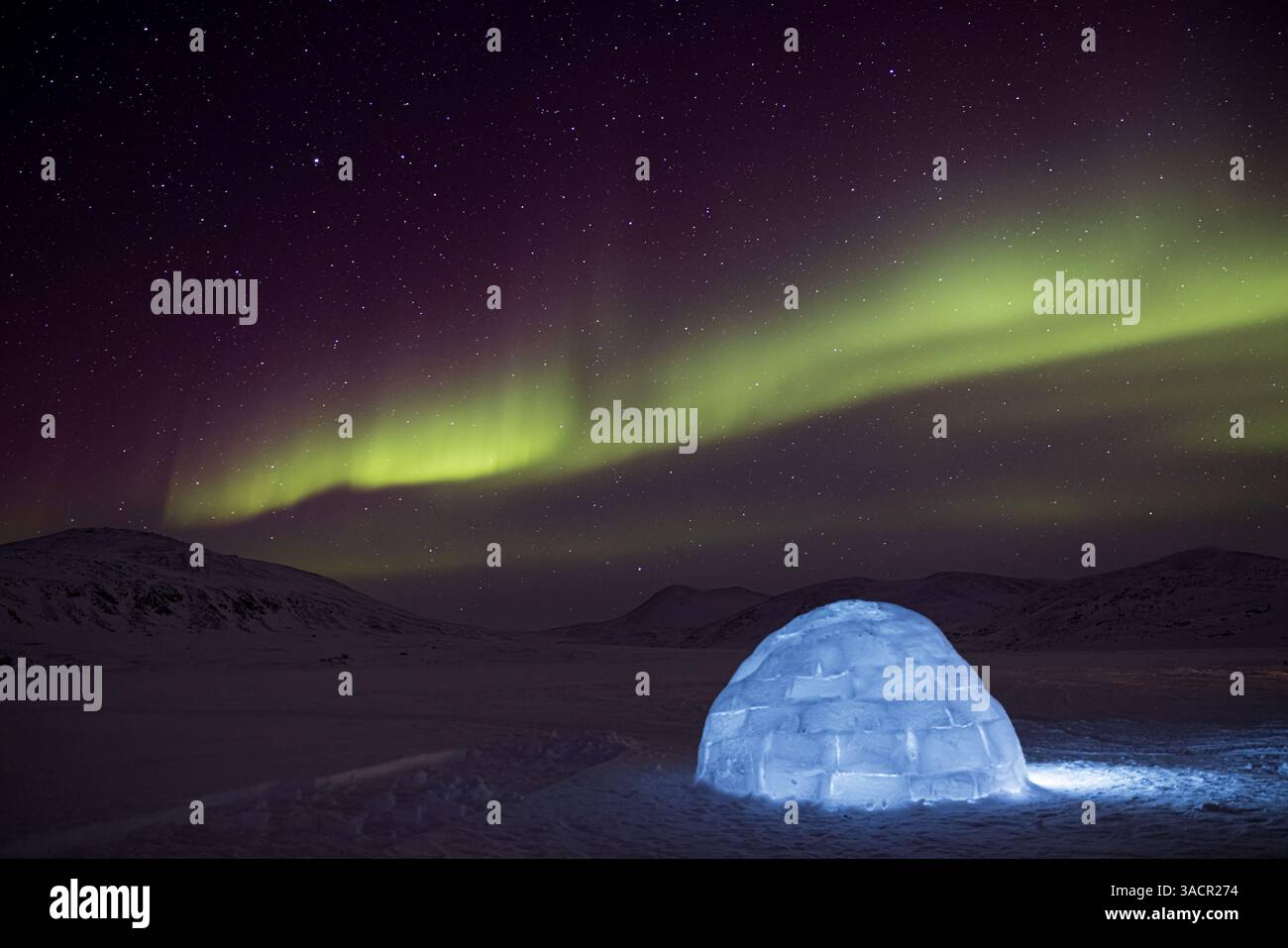 Aurora Borealis, Northern Lights, and stars over snow and mountains of ...