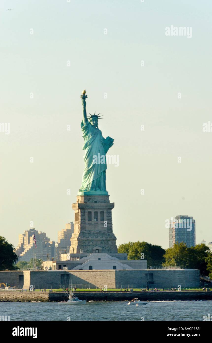 Miss Liberty in front of Ellis Island Stock Photo - Alamy