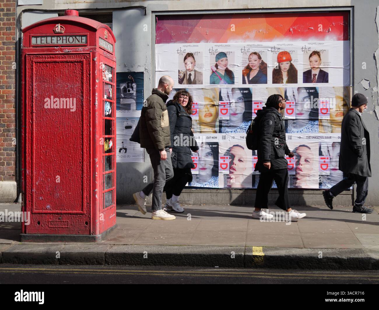 Dean Street in Soho London UK, commuters walk past iconic red phonebox ...