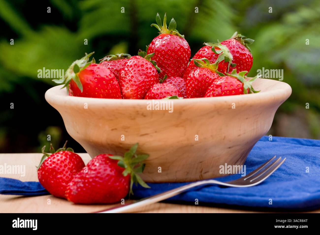 Strawberry in wooden bowl hi-res stock photography and images - Alamy