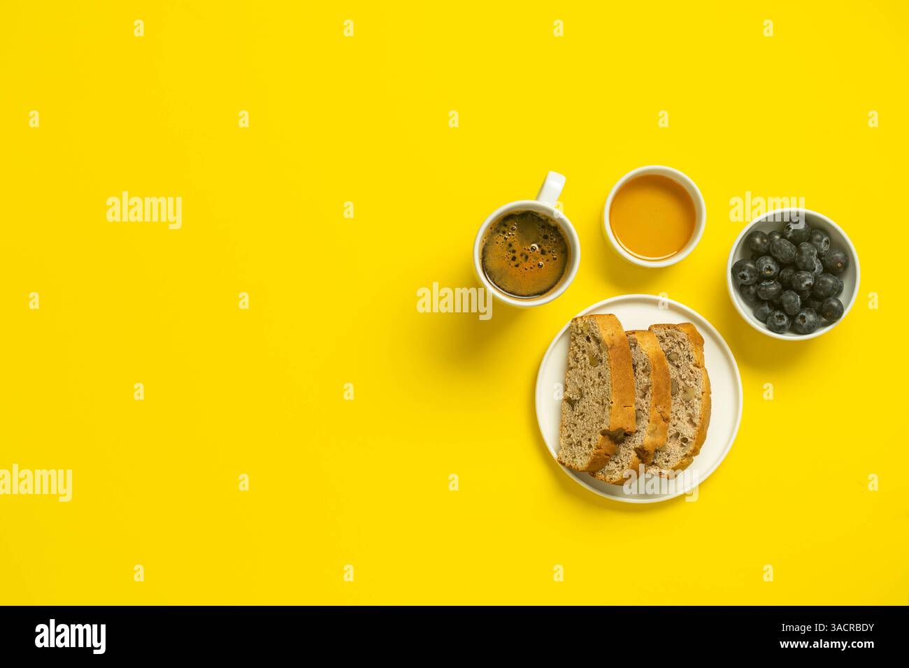 Nut cake and juice on bright yellow paper background Stock Photo - Alamy