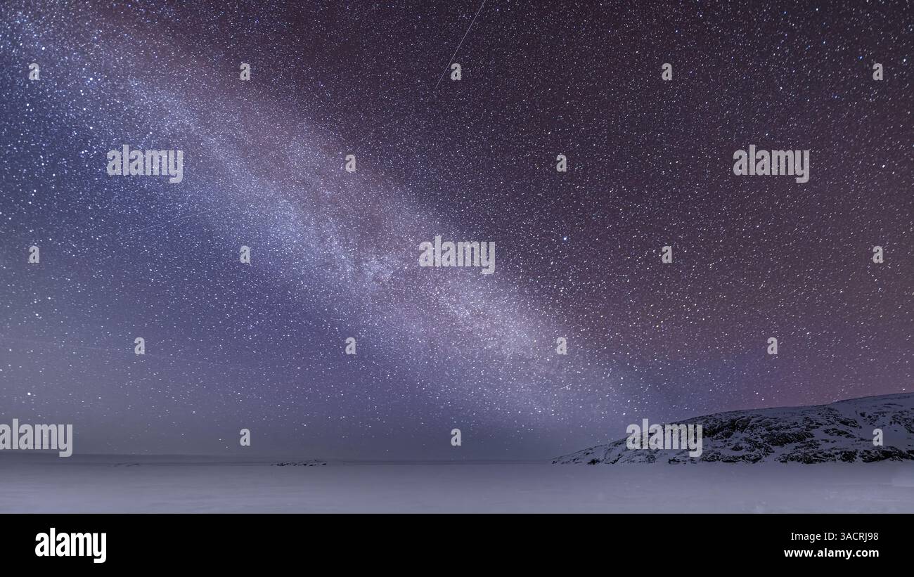Milky way over the snow and mountains of Baffin Island, Nunavut, Canada ...