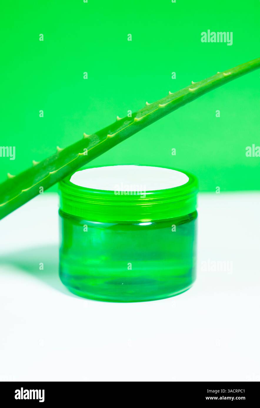 Fresh aloe vera gel and plant leaf, set on a green background. Perfect ...