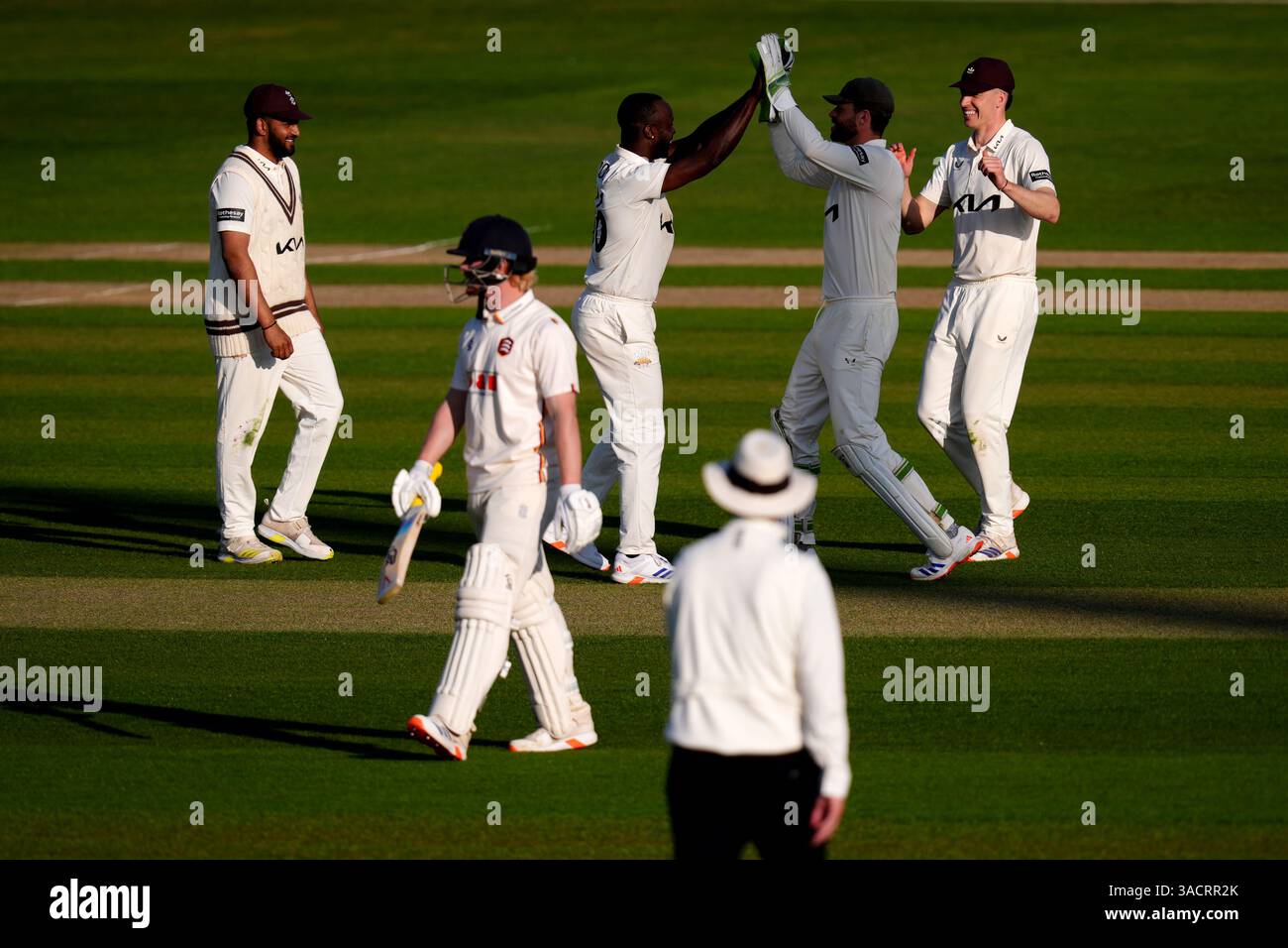 Surrey’s Kemar Roach (centre) celebrates taking the wicket of Essex’s ...