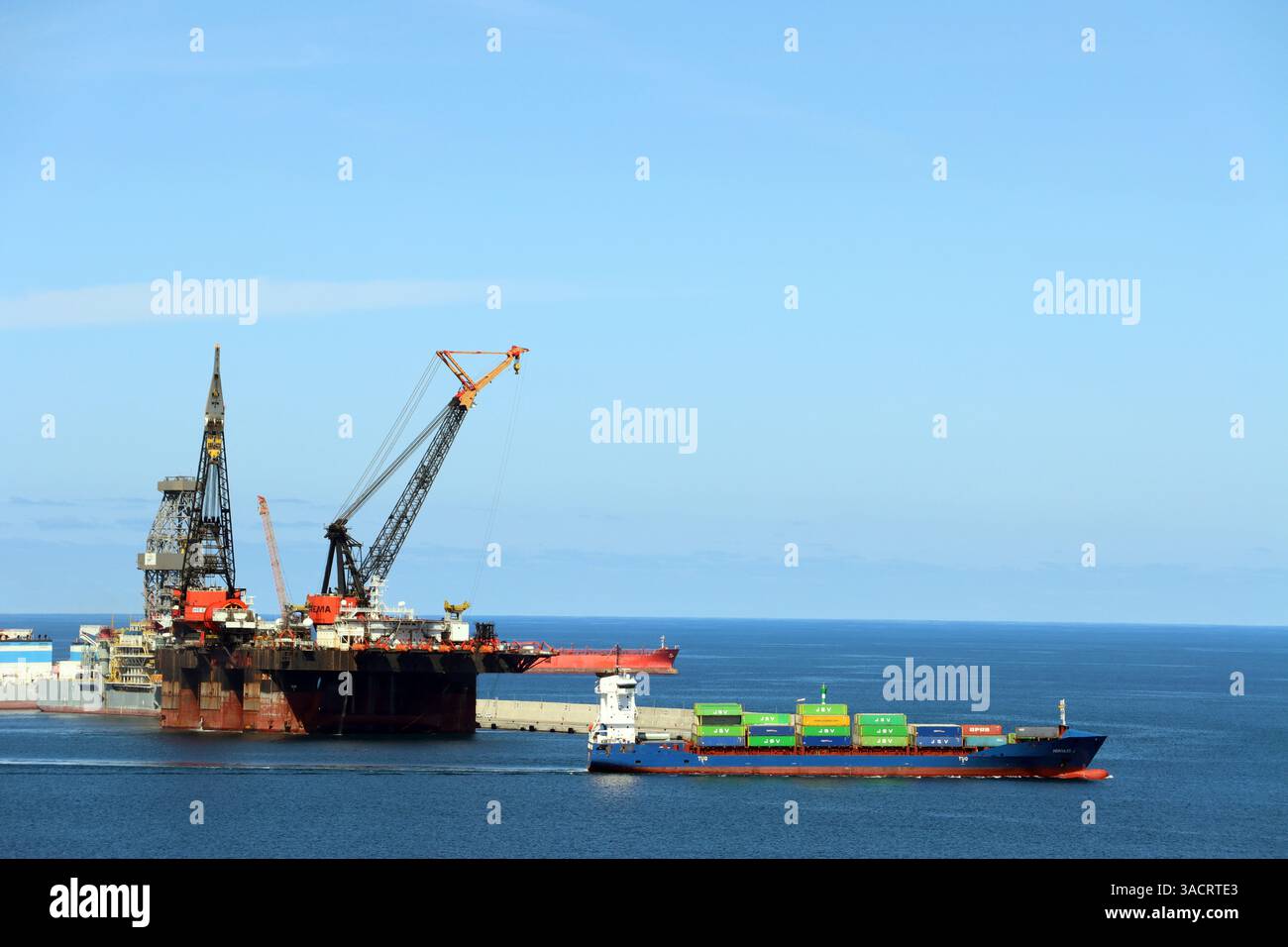 Small container ship leaves the port of Las Palmas, Gran Canaria, Spain ...