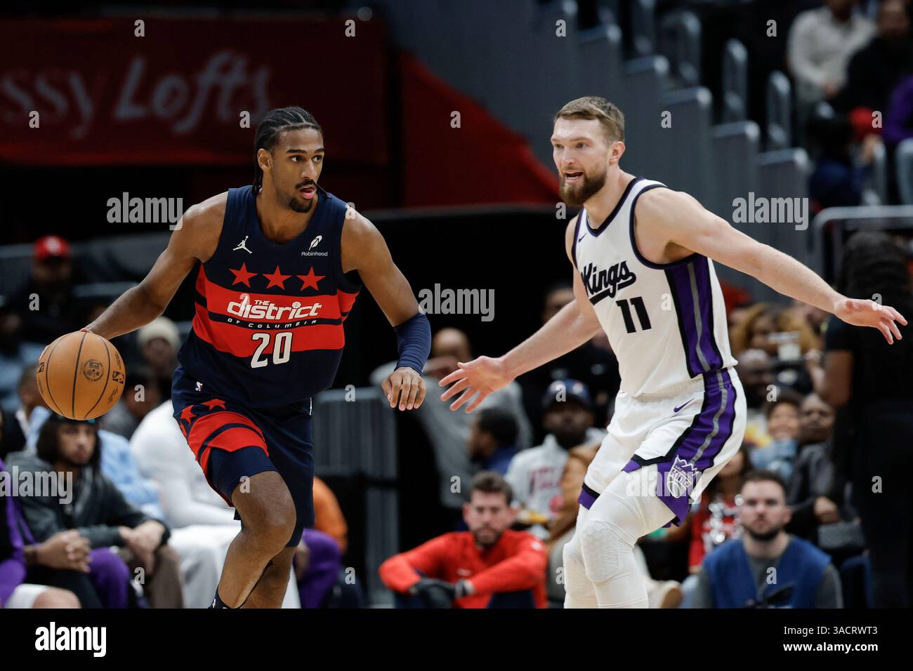 Washington Wizards forward Alex Sarr (20) handles the ball against Sacramento Kings forward ...