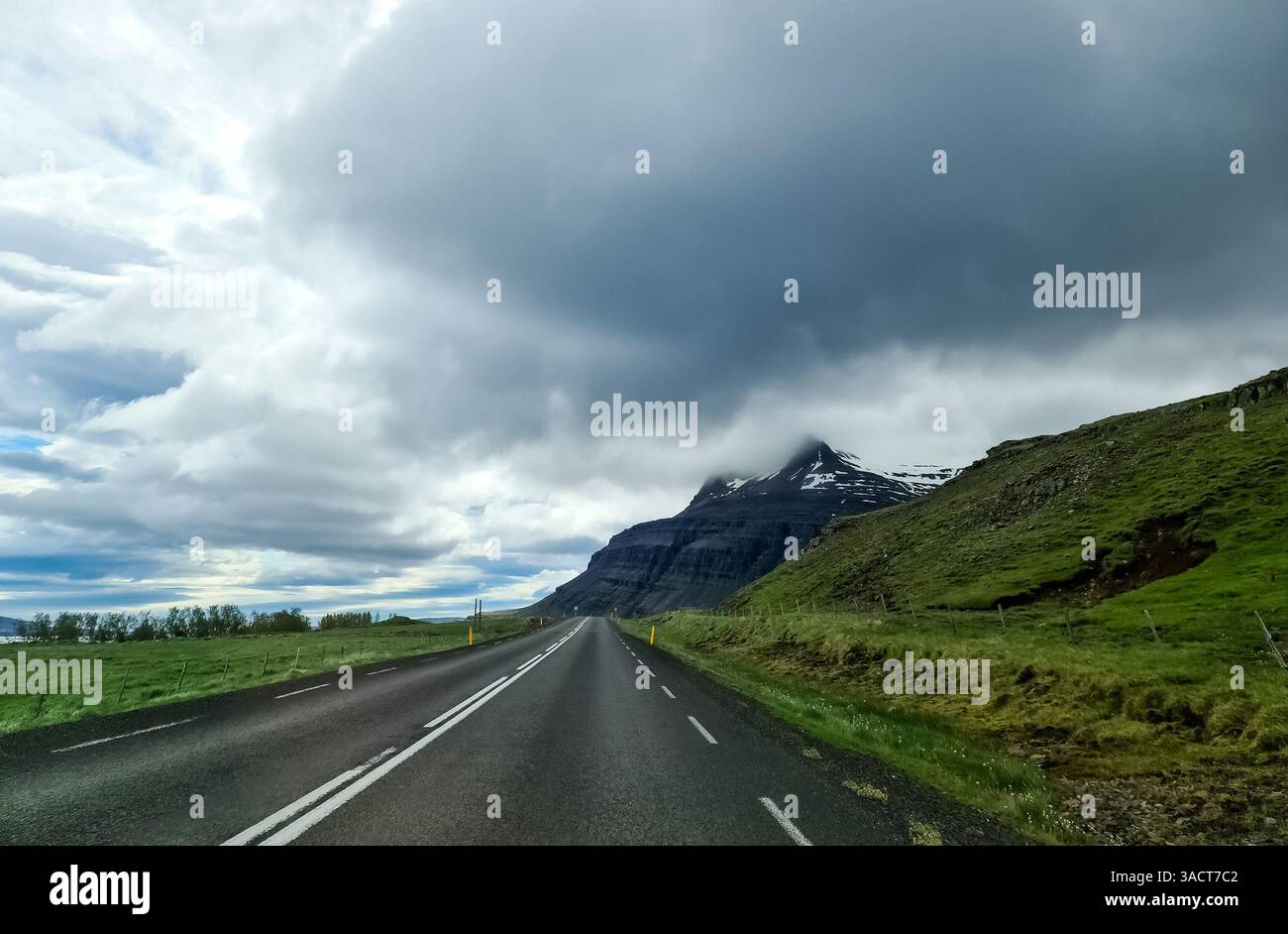 Scenic route winding through lush greenery, leading toward a majestic ...