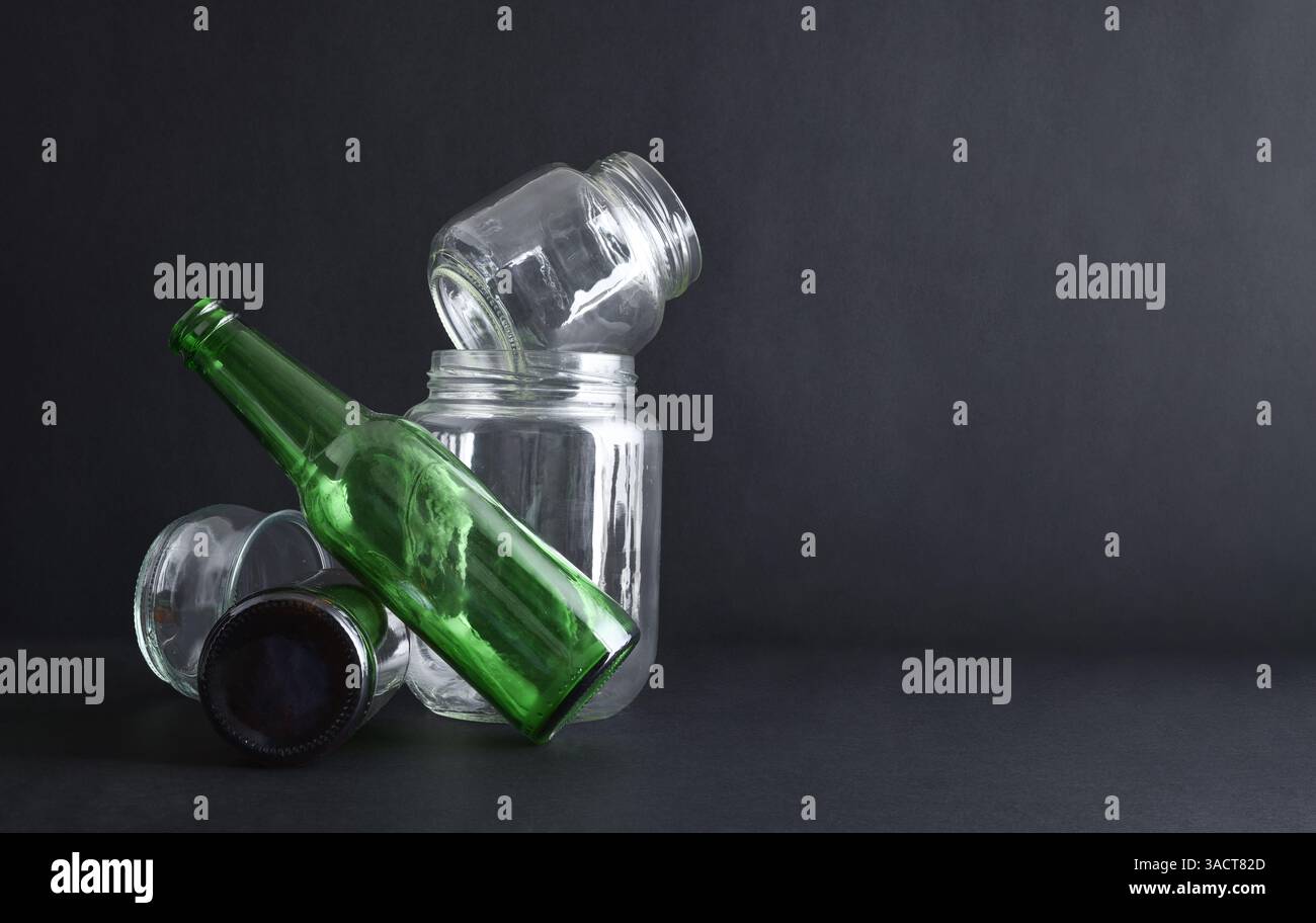 Glass pollution and recycling concept with heap of glass bottles and ...