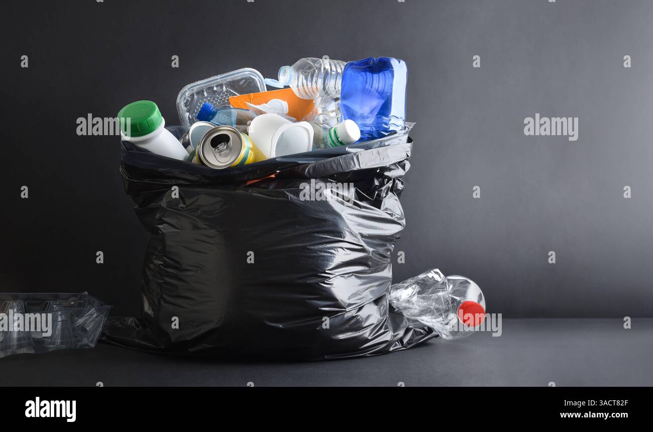 Background with detail of black plastic garbage bag full general waste ...