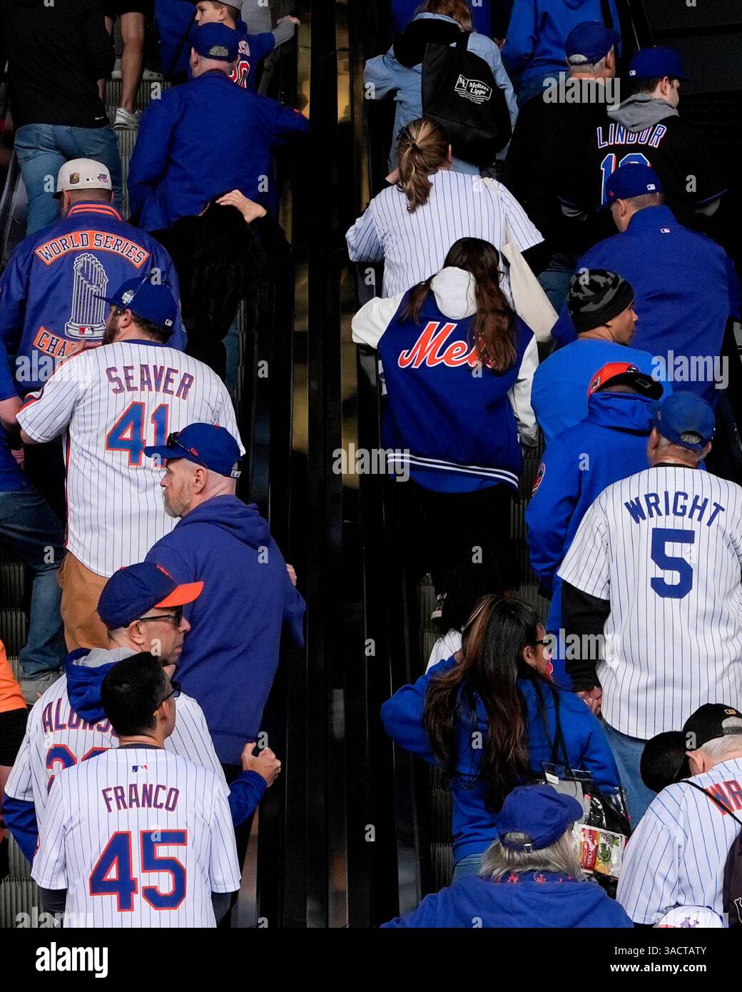 New York Mets fans ride the escalators to the concourse before a ...