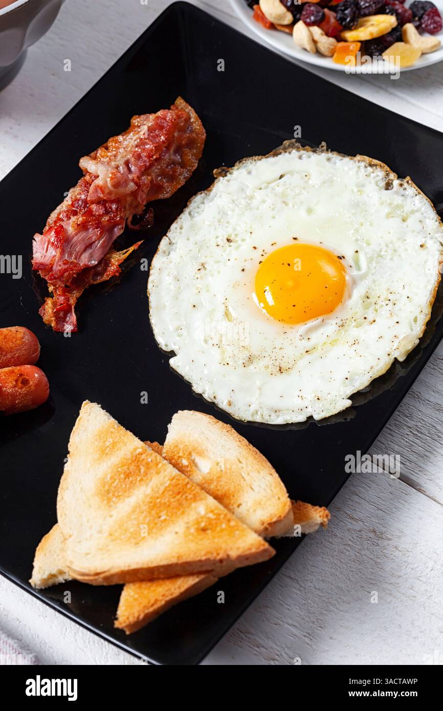 Traditional full english breakfast includes a fried egg hi-res stock ...