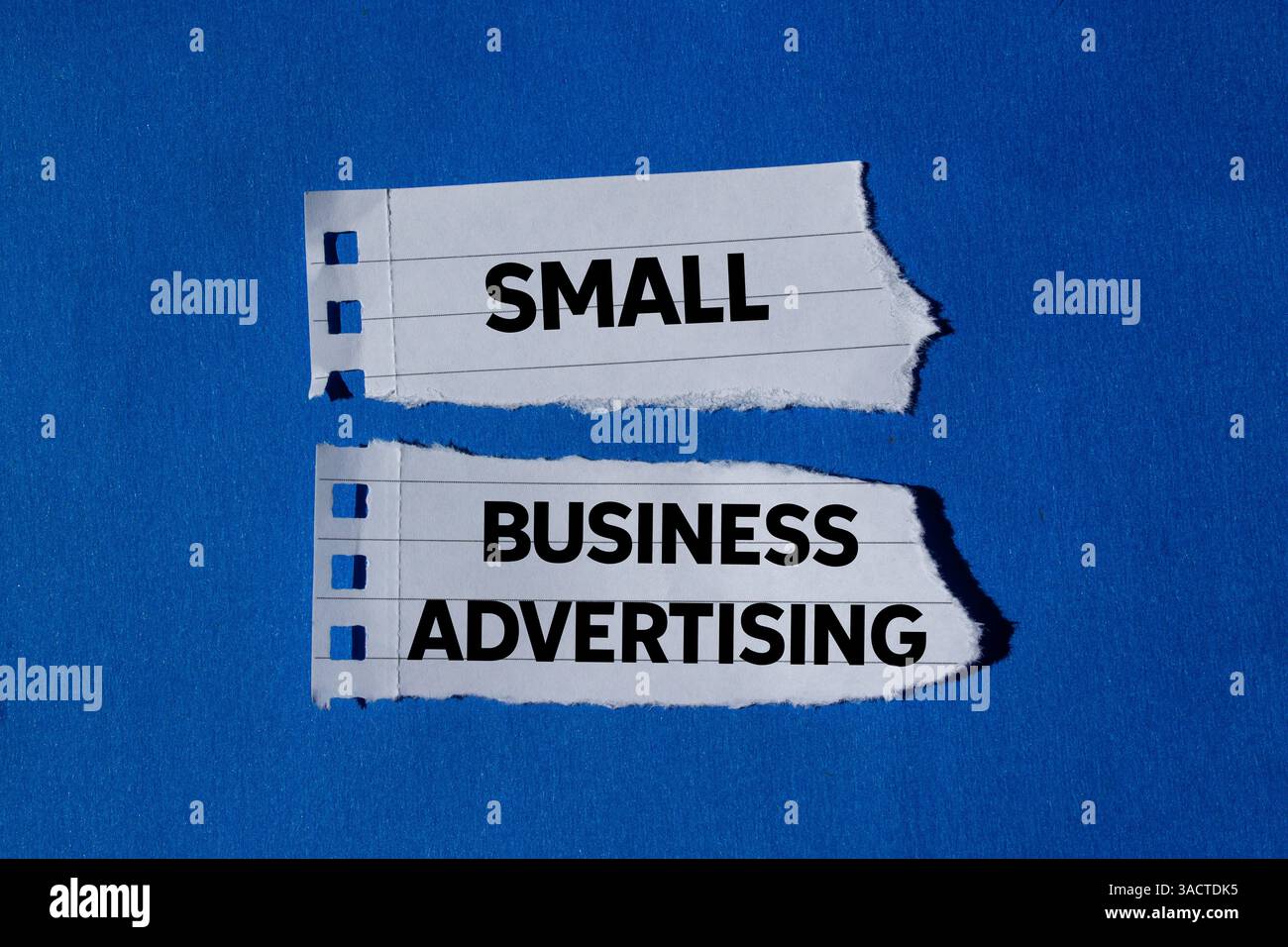 Small business advertising message written on ripped torn white paper ...