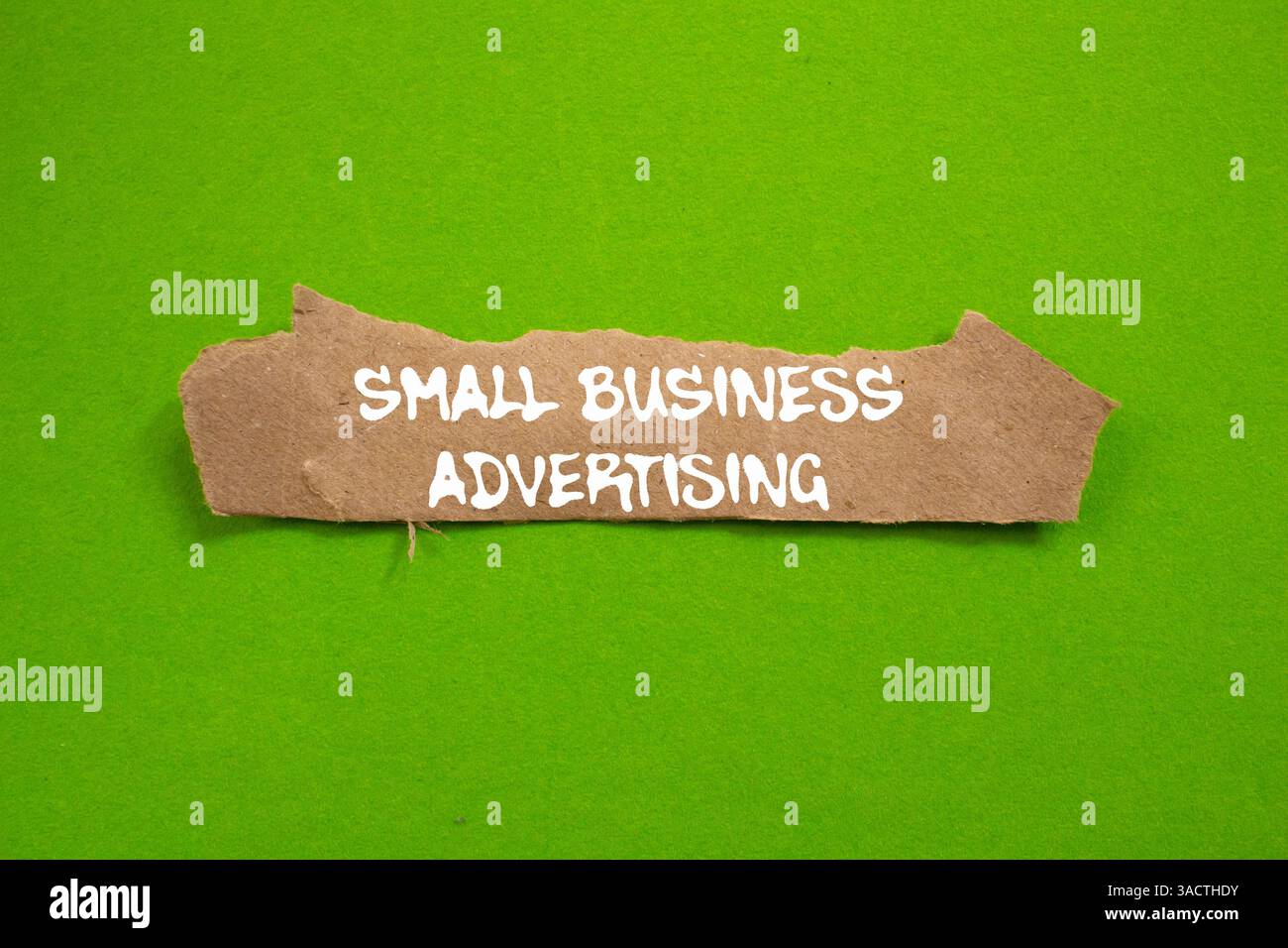 Small business advertising message written on ripped torn brown paper ...