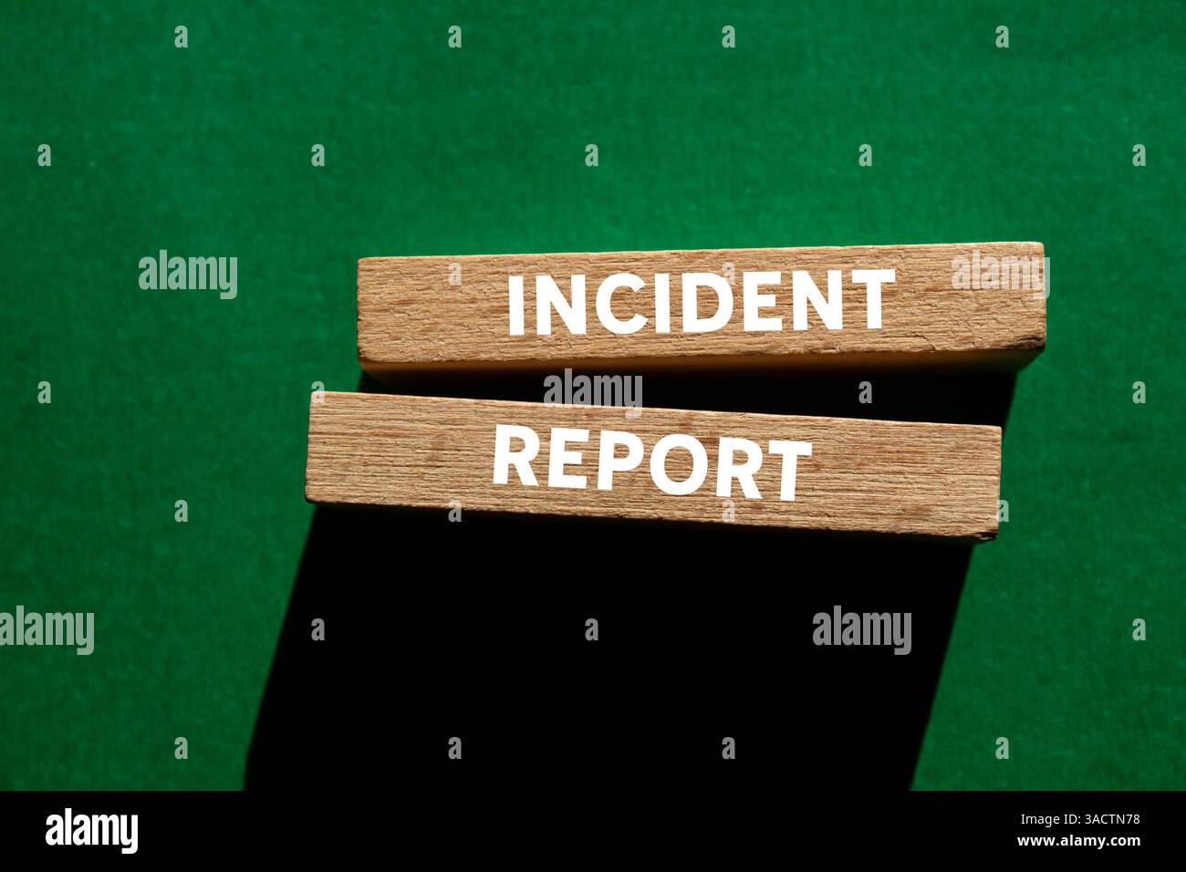 Incident report message written on wooden blocks on green background ...