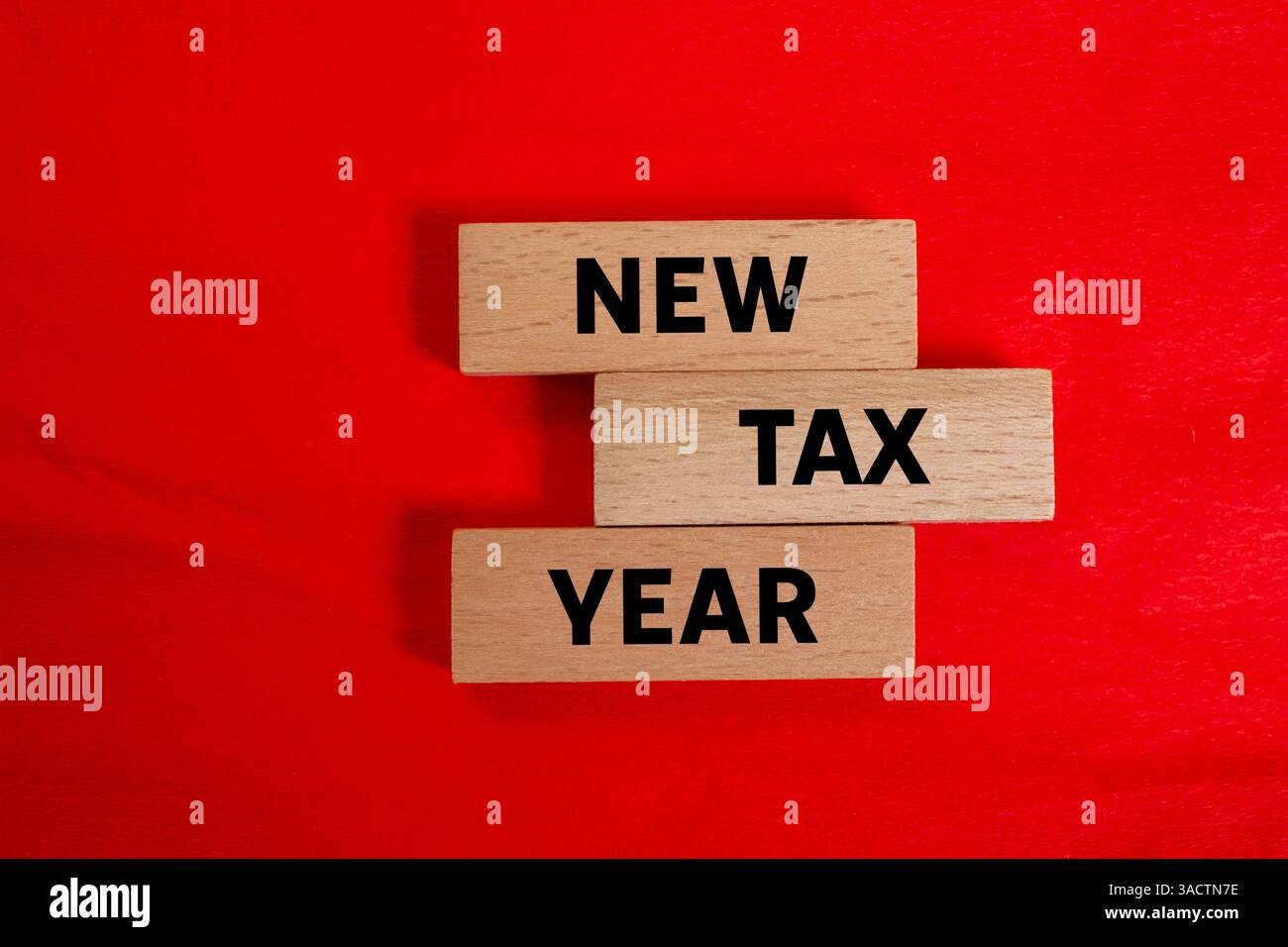 New tax year message written on wooden blocks on red background ...