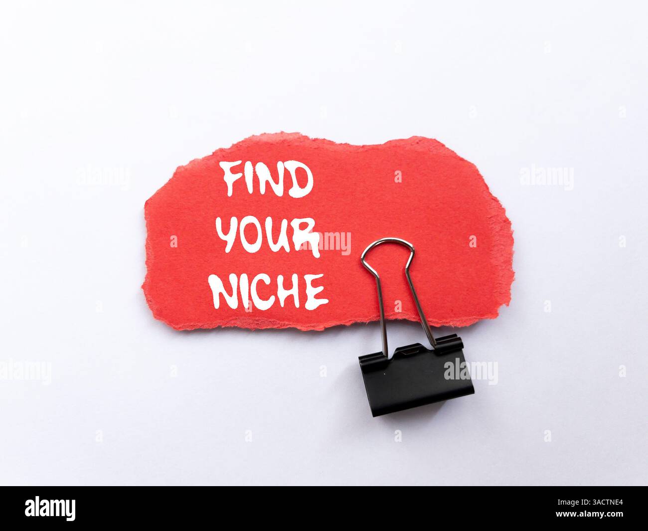 Find your niche message written on ripped torn red paper piece on white ...
