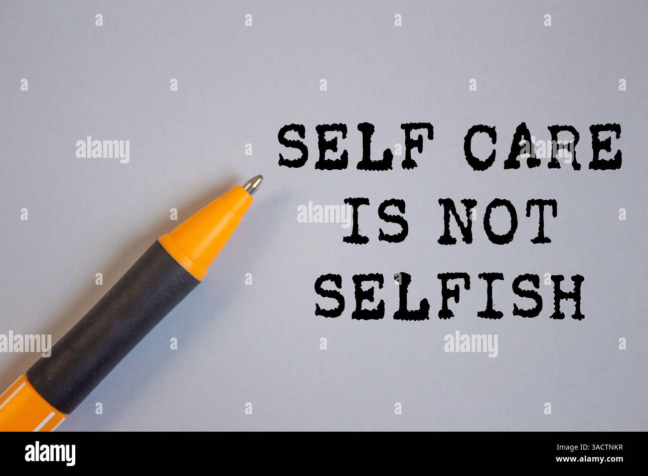 Self care is not selfish message written on gray background with a pen ...