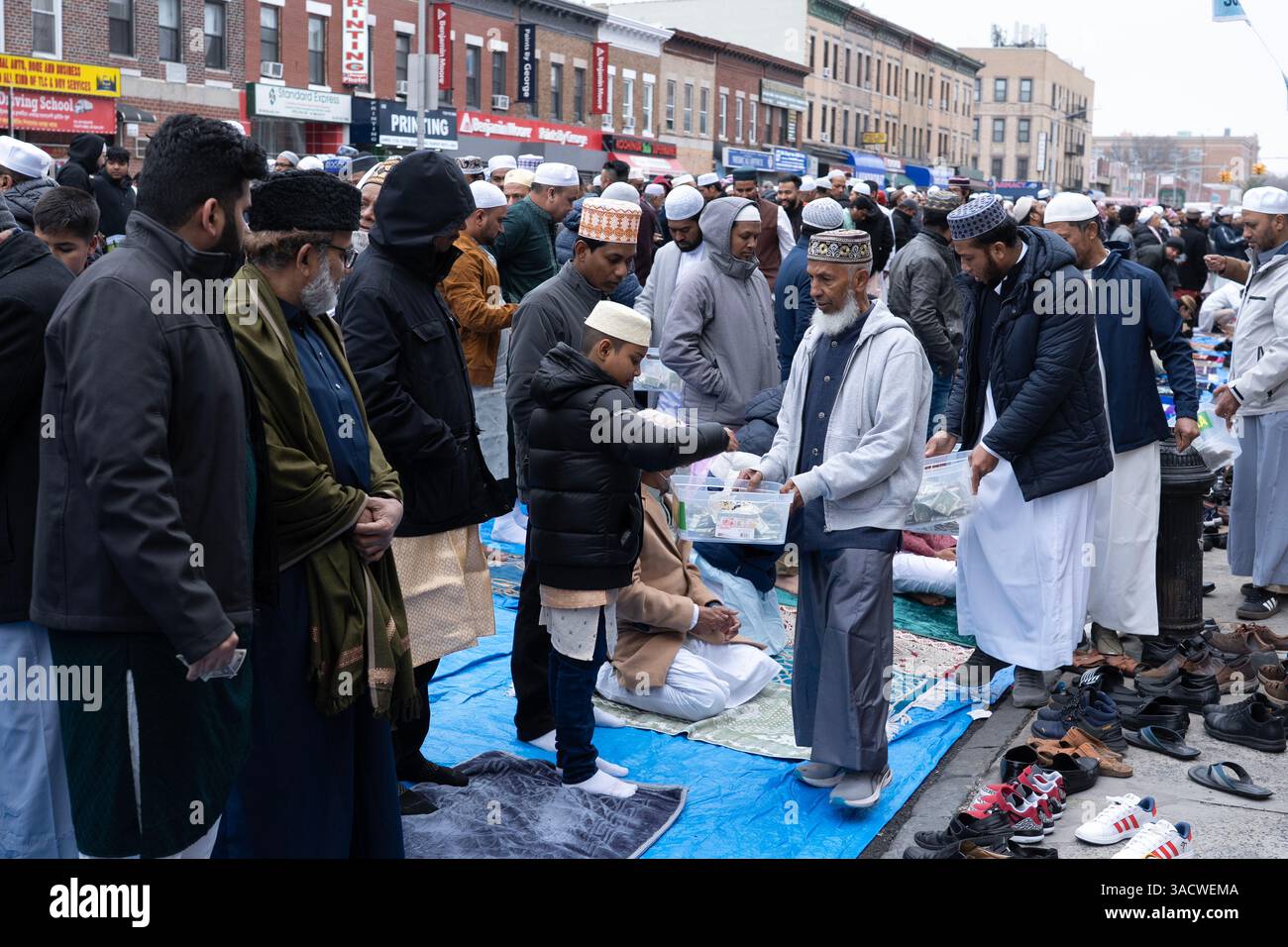 Muslim men pray on Eid on McDonald Ave in Brooklyn NY in the "Little ...