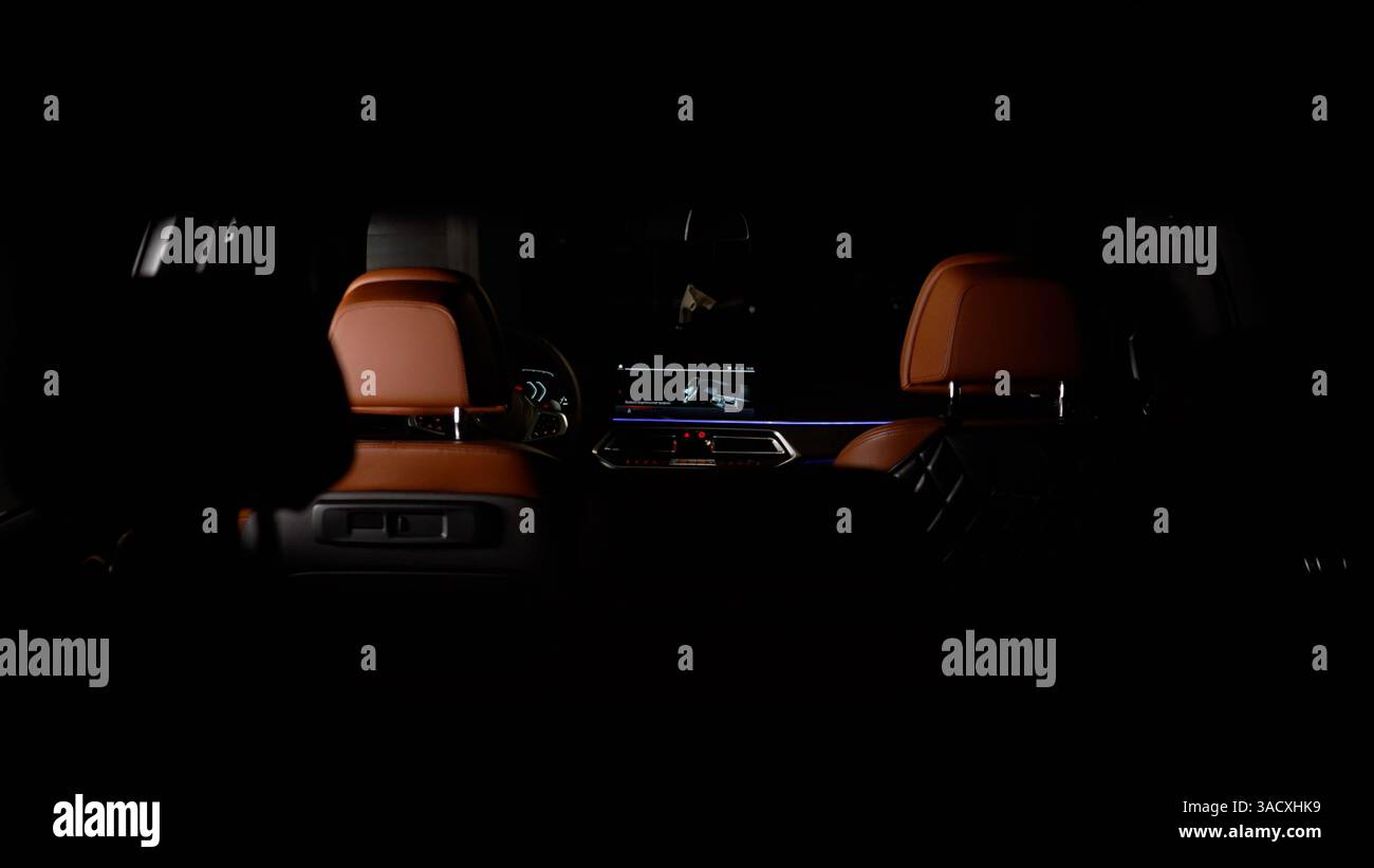Empty car interior at night showing infotainment system displaying a 3d ...