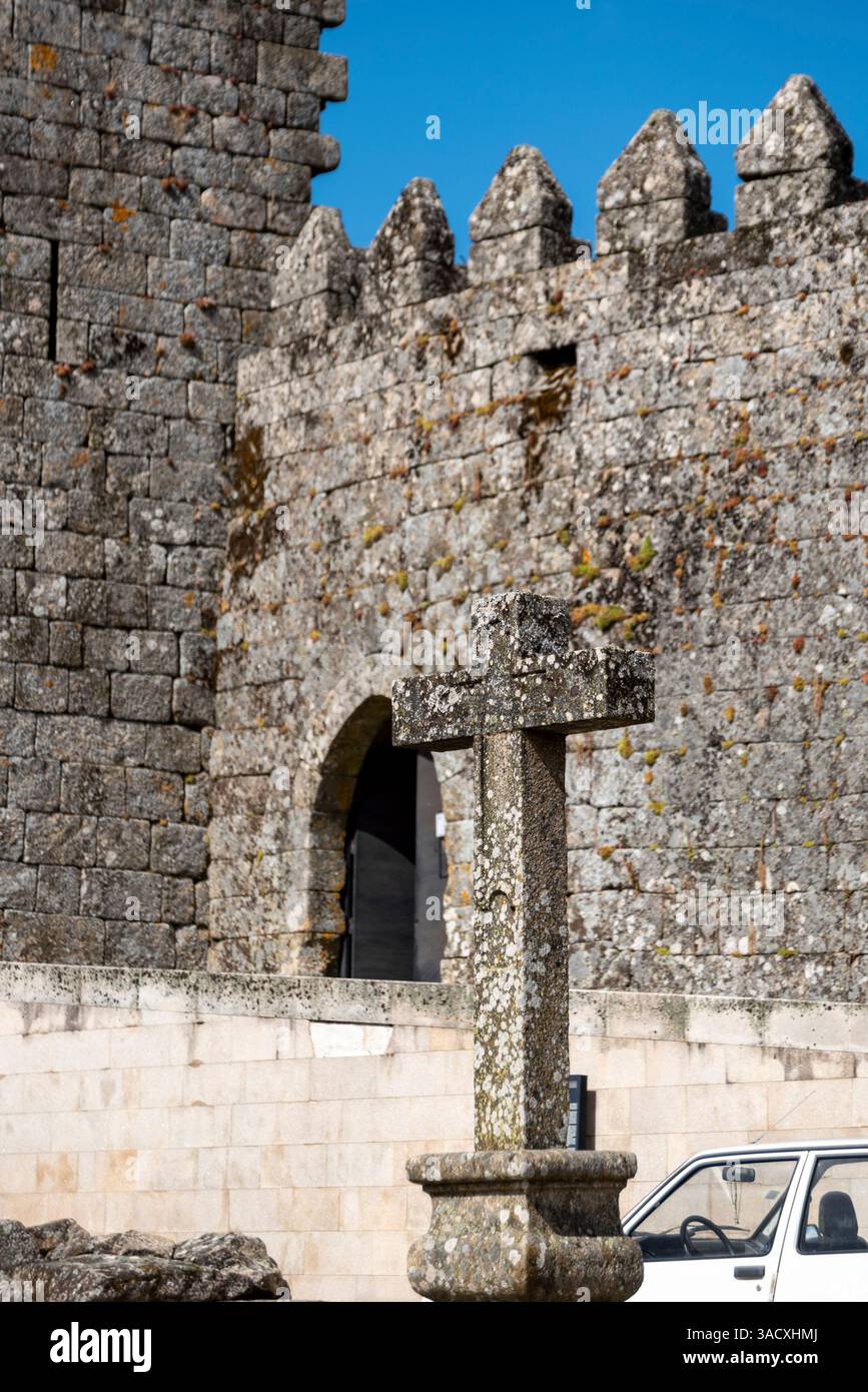 A medieval cross in front of the entrance to Tracoso castle, Portugal ...