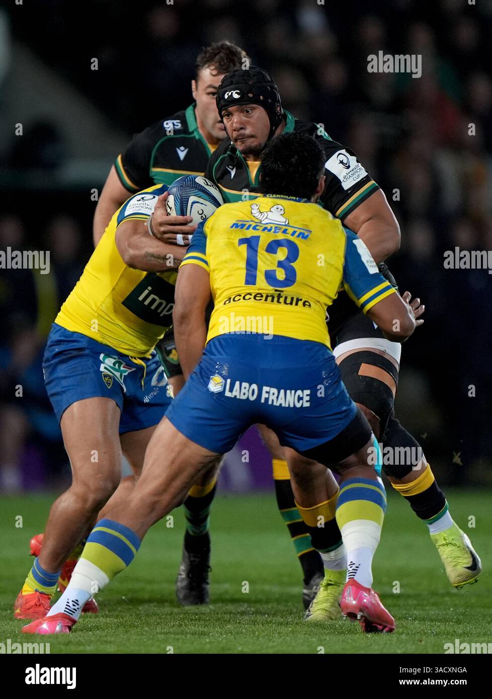 Northampton Saints' Juarno Augustus (centre) is tackled by Clermont ...