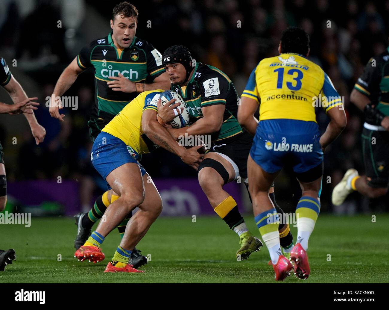 Northampton Saints' Juarno Augustus (centre) is tackled by Clermont ...