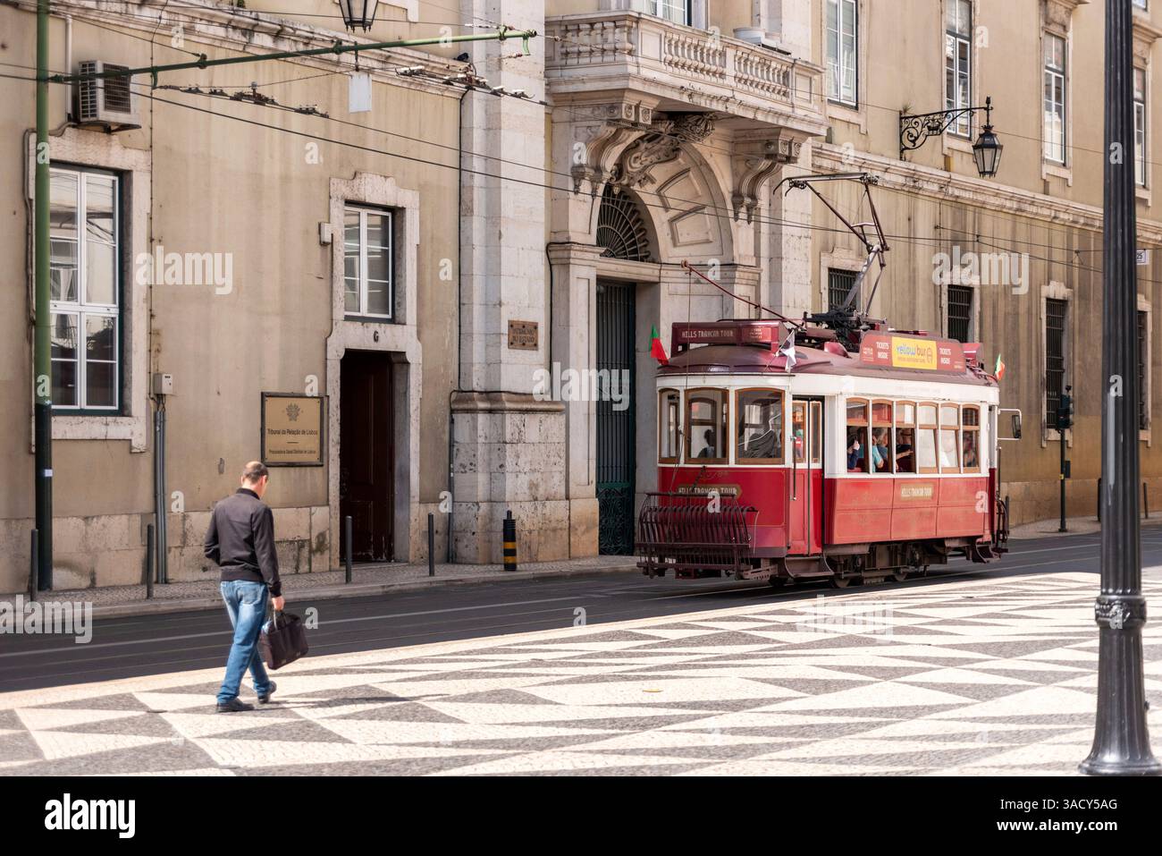 Historic red tram driving through the streets of downtown lisboa hi-res ...