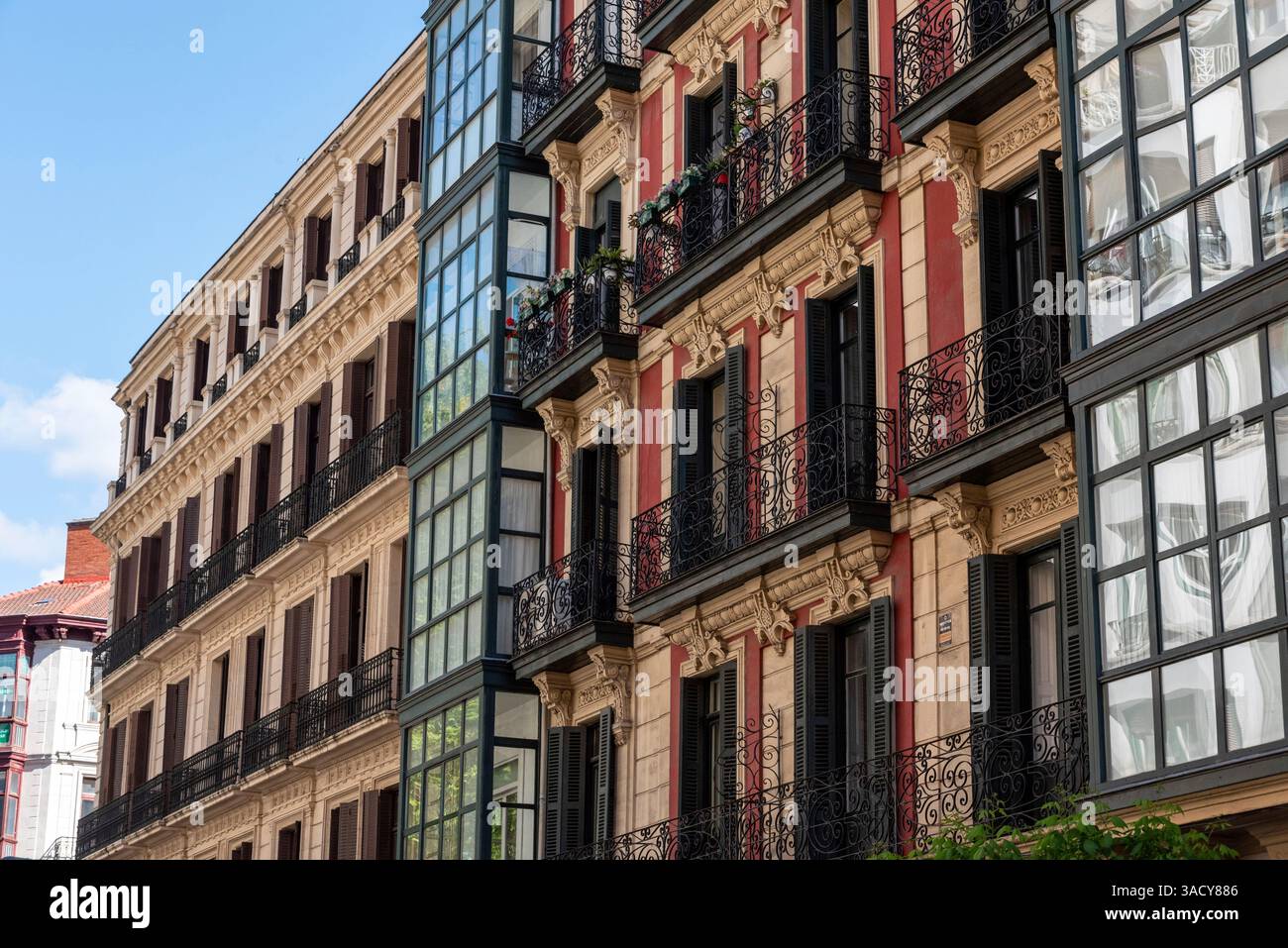 Typical facade of residential buildings with balconies and bay windows ...