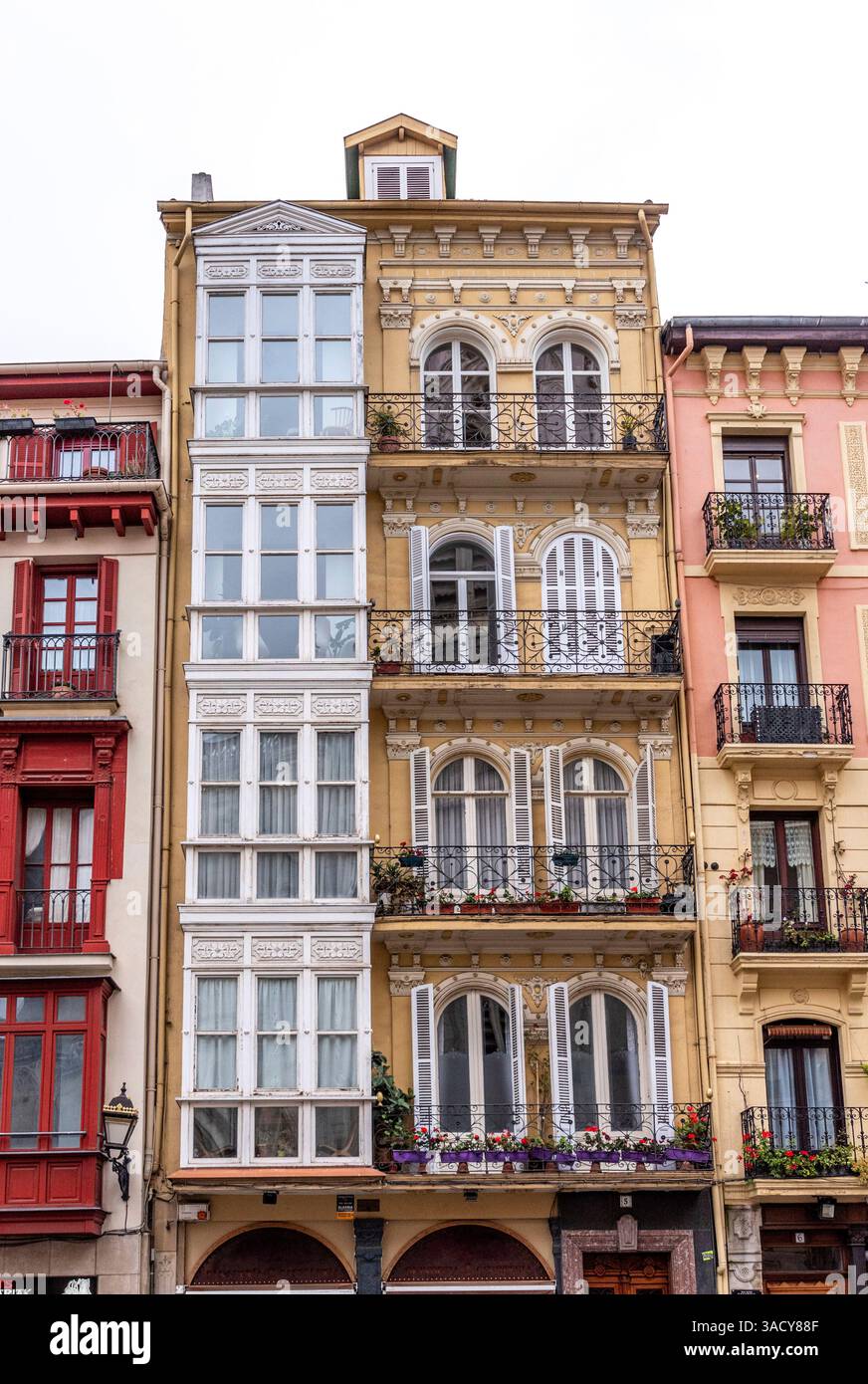 Typical facade of residential buildings with balconies and bay windows ...
