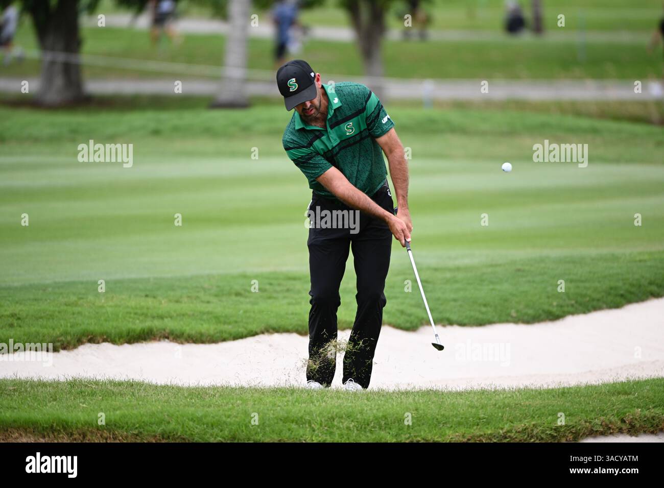 Charl Schwartzel of the Stinger GC hits a shot from the edge of a ...