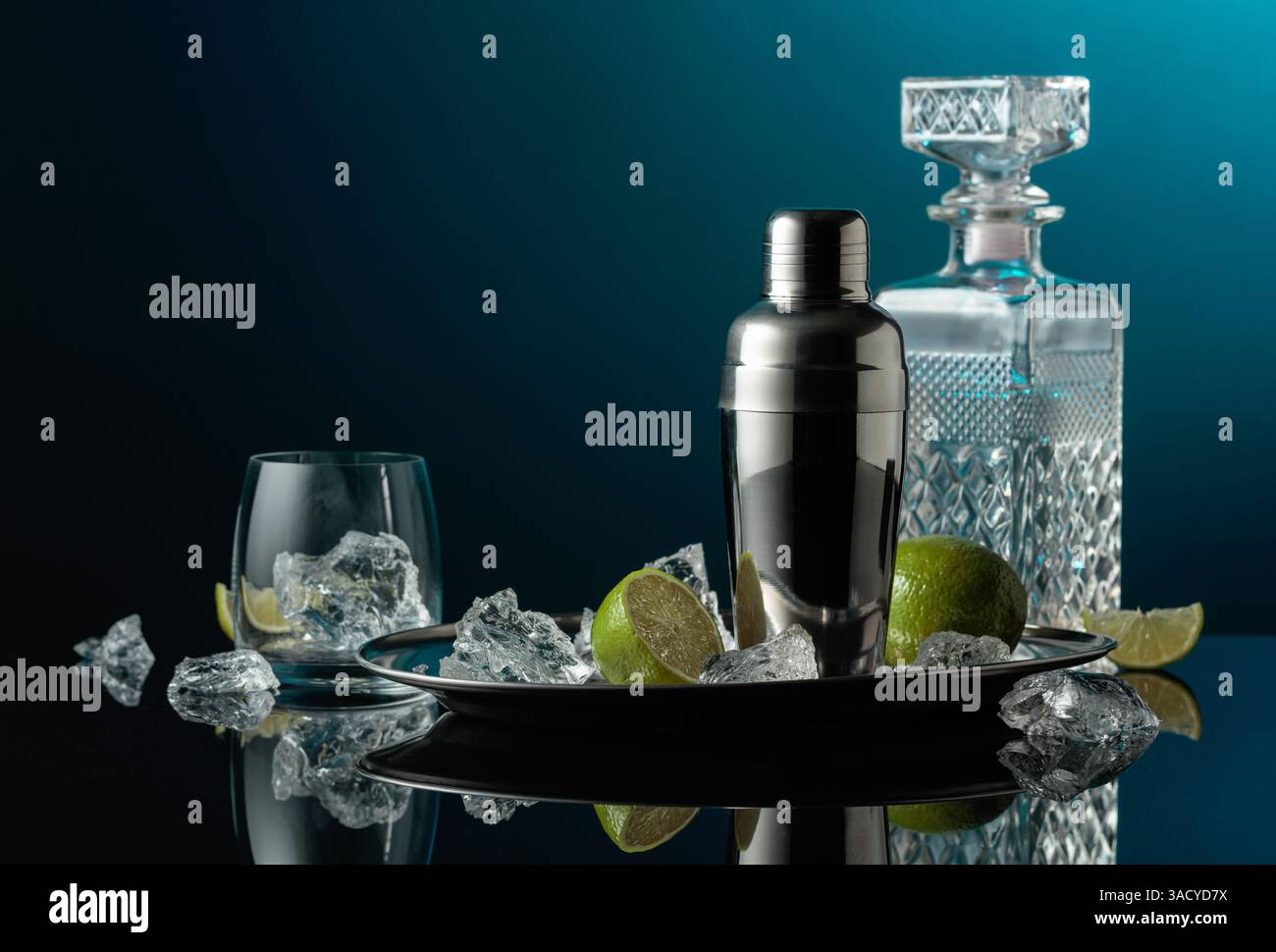 Shaker with ingredients for cocktail making. On a black reflective ...