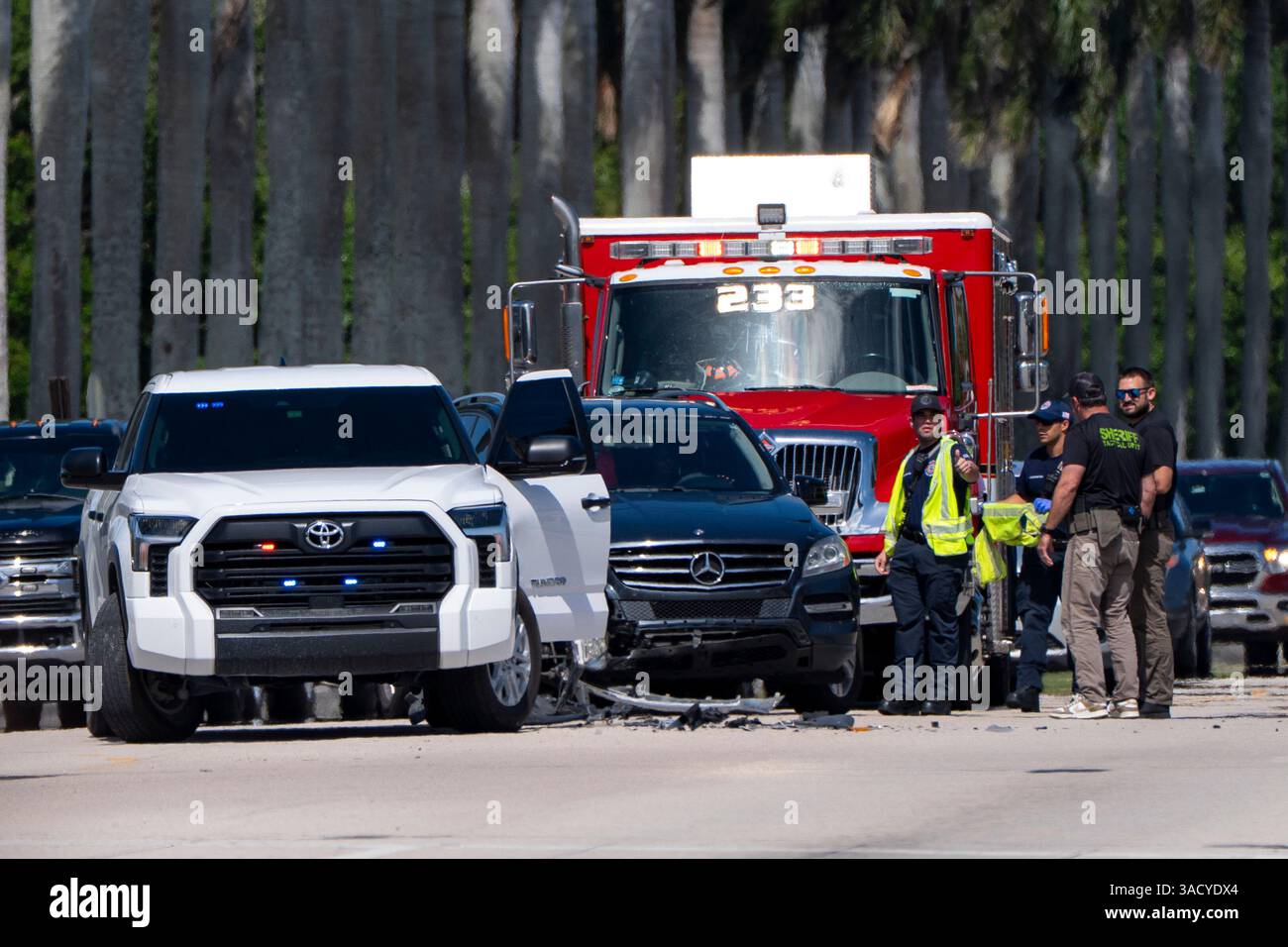 Police investigate near a white Toyota Tundra pickup unmarked police ...
