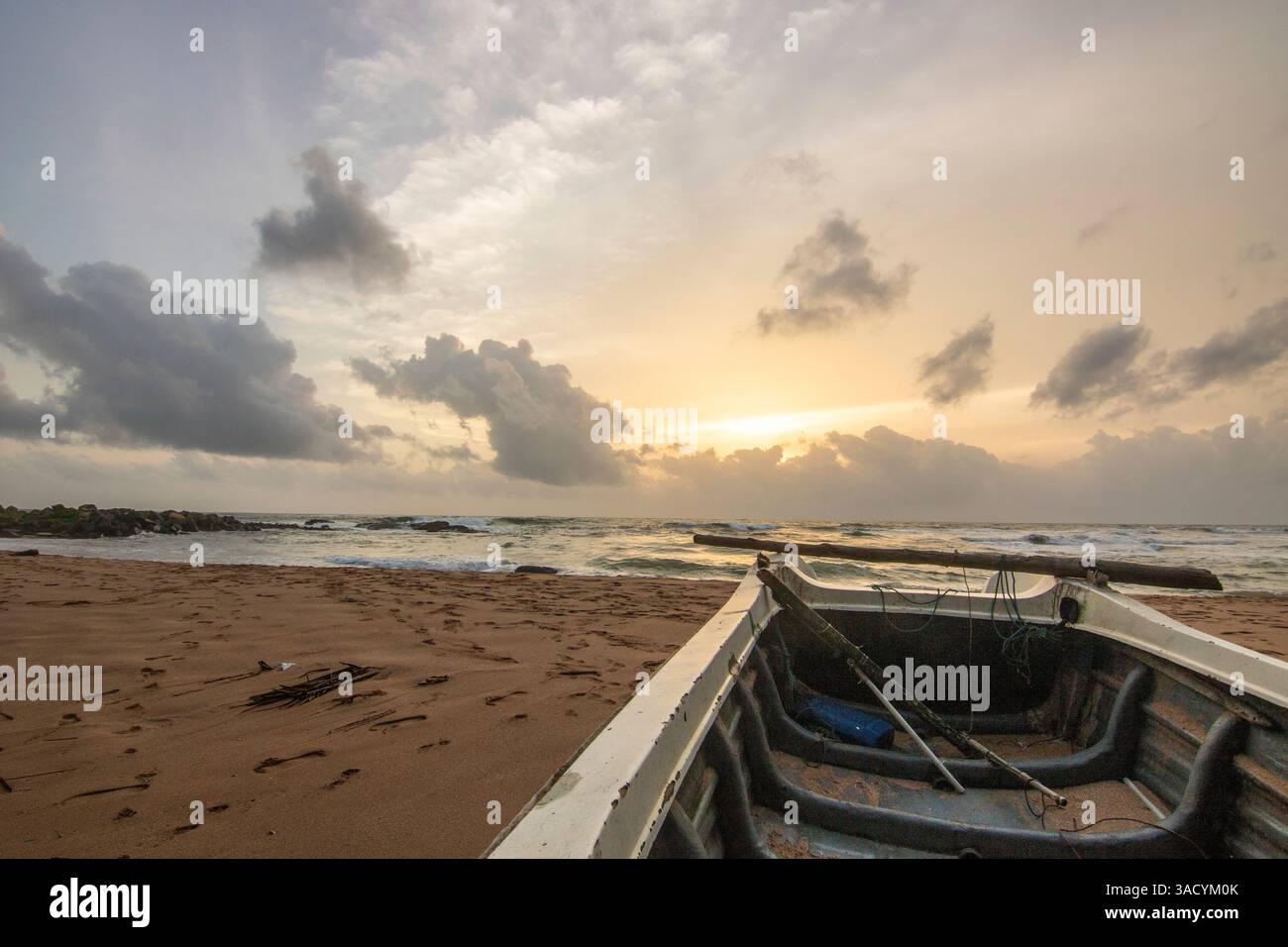 Landscape by the sea and sandy beach, a boat lies in the sand and adds a special touch to the ...