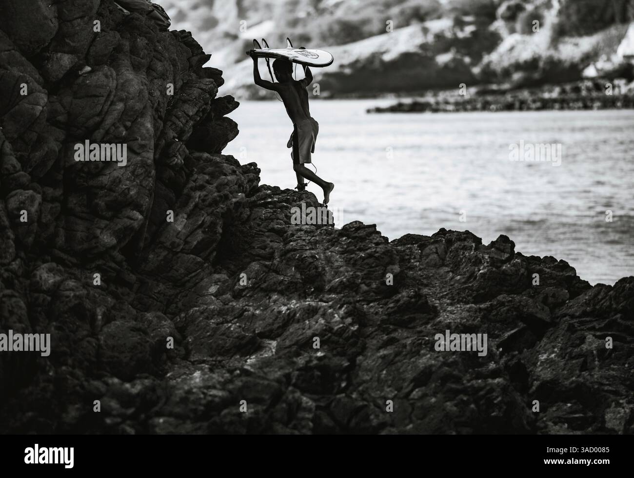 Child carries surfboard overhead, Tarrafal, Cape Verde, West Africa ...