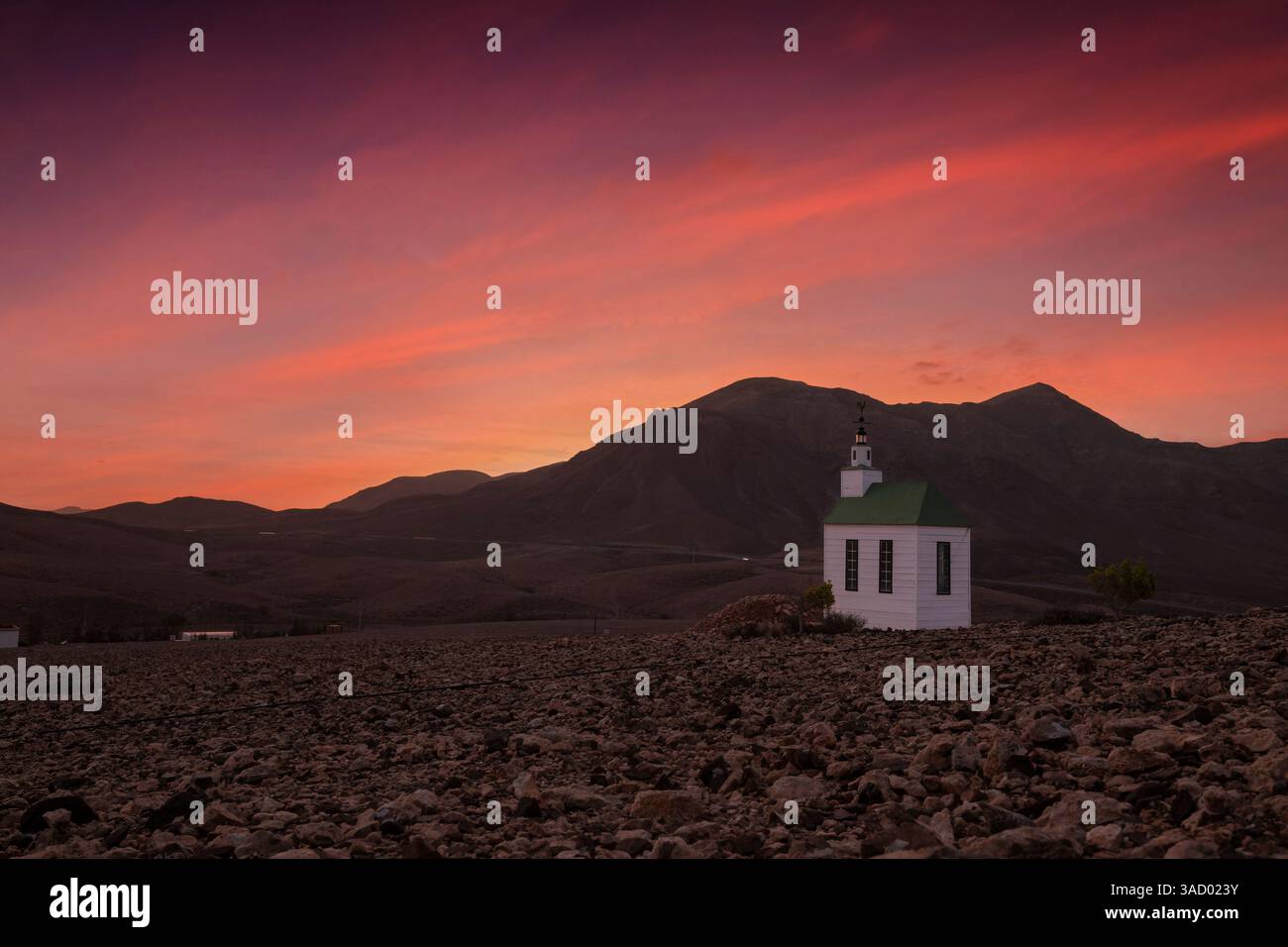 Small white wooden chapel in a monotonous rocky volcanic landscape ...