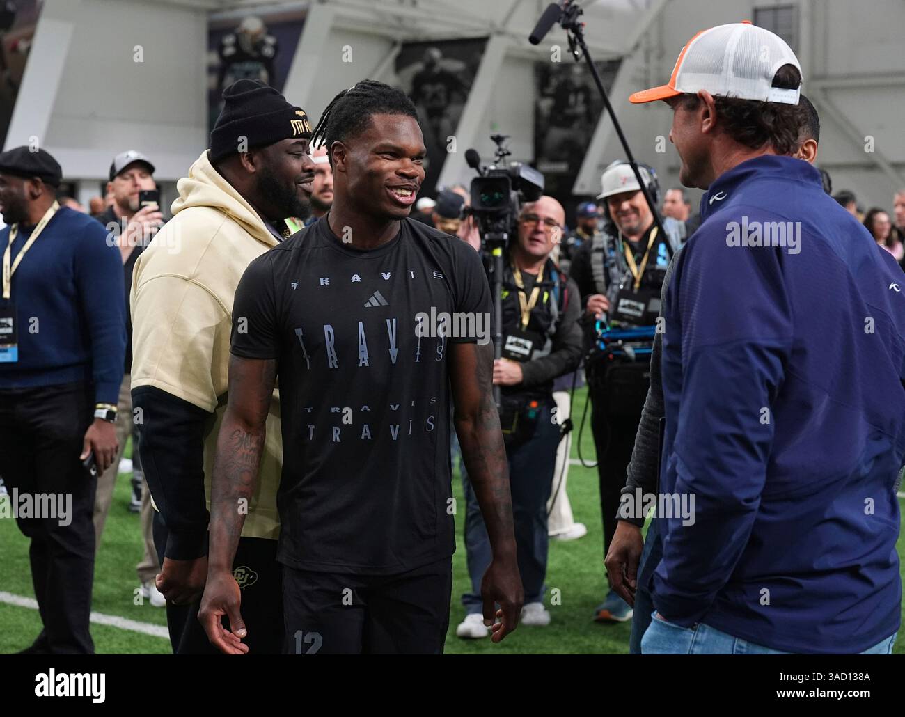Colorado wide receiver Travis Hunter, left, greets a scout during the ...