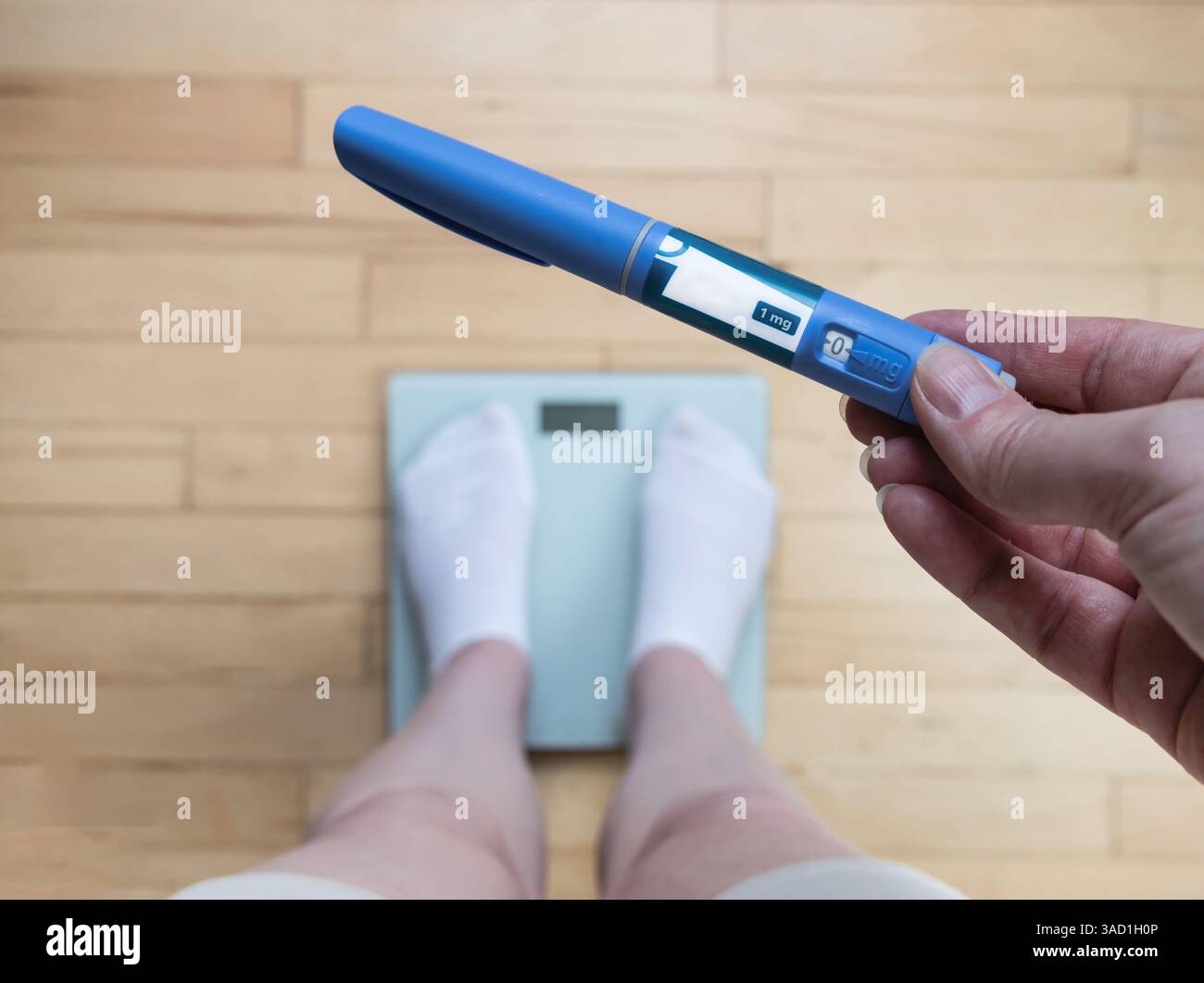Ozempic Insulin injection pen for diabetics and weight loss. Woman weighs herself and holds ...