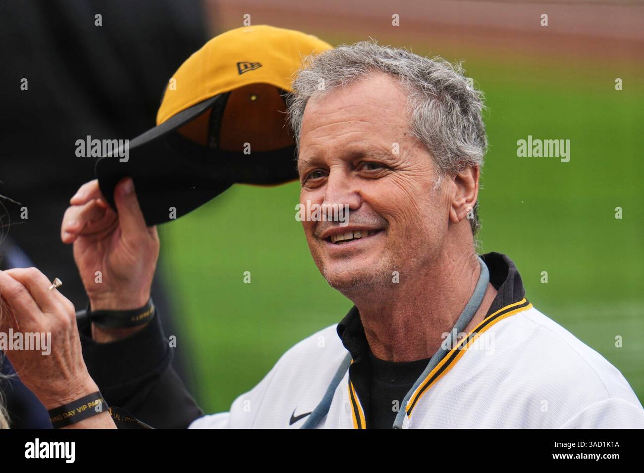 Former hostage Marc Fogel puts on his cap before throwing out a ...