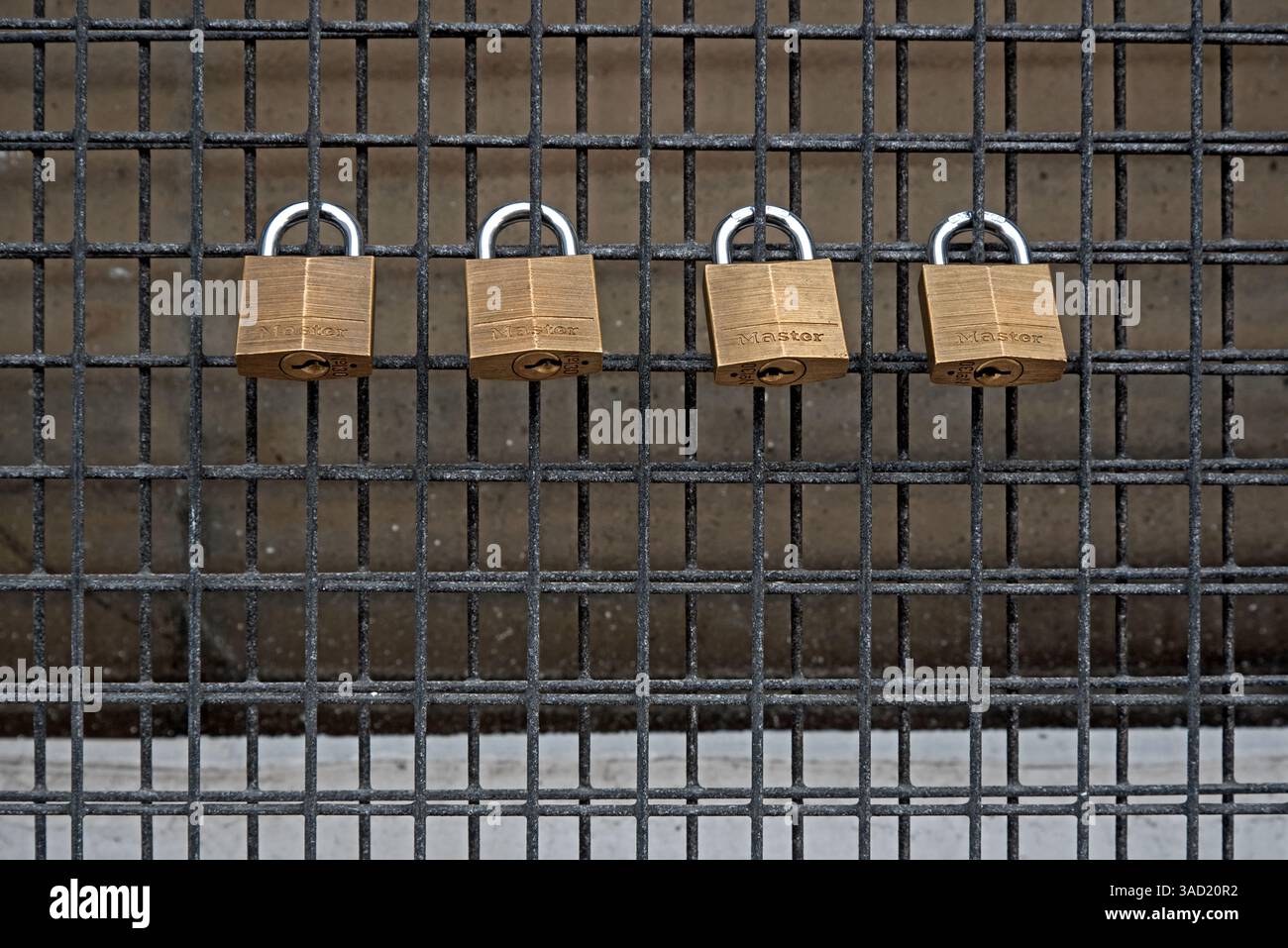 Four Master padlocks on a grill Stock Photo - Alamy