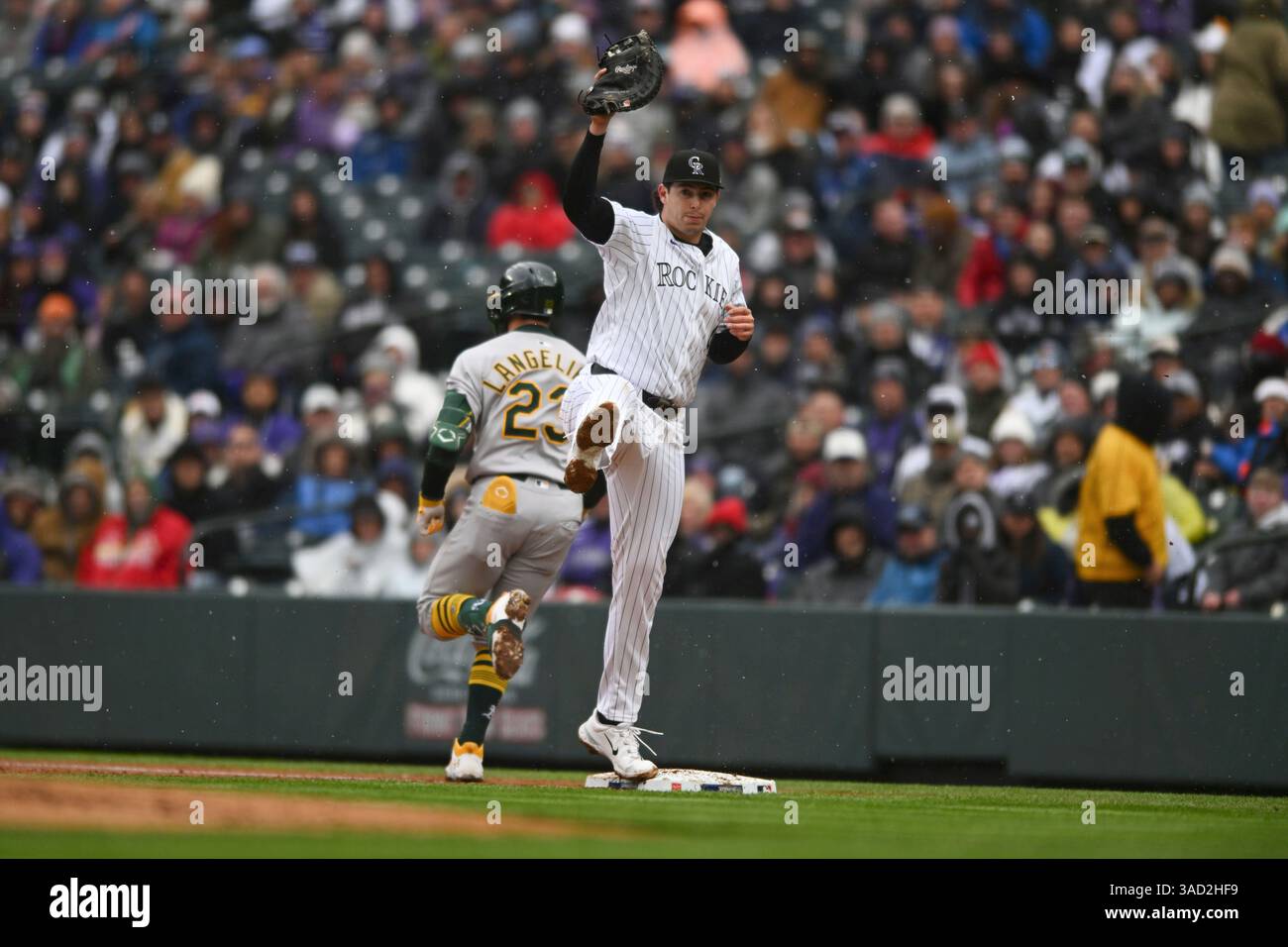 Colorado Rockies first baseman Michael Toglia (4) lands on the bag late ...