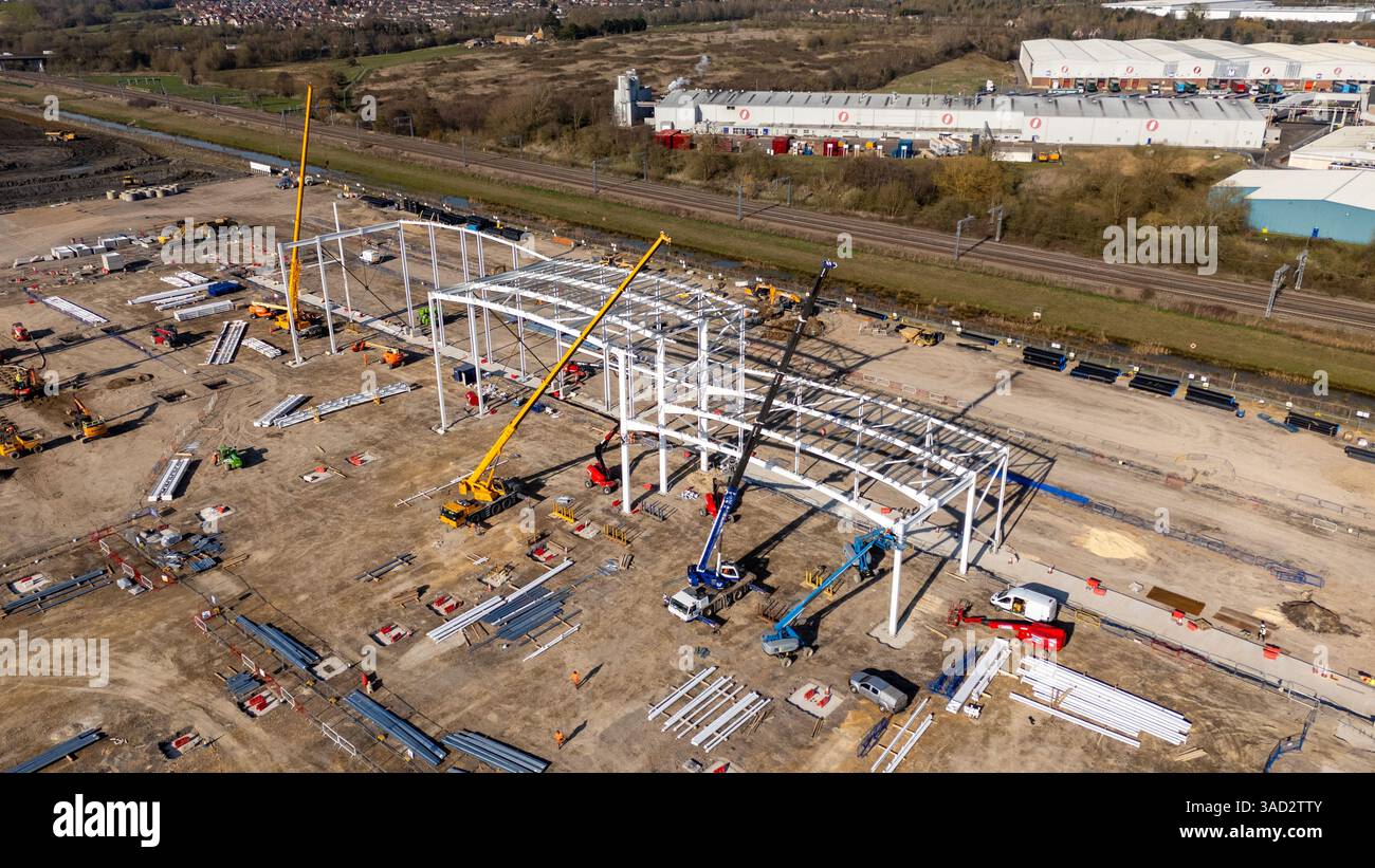 Aerial view of a construction site showing cranes erecting a steel ...